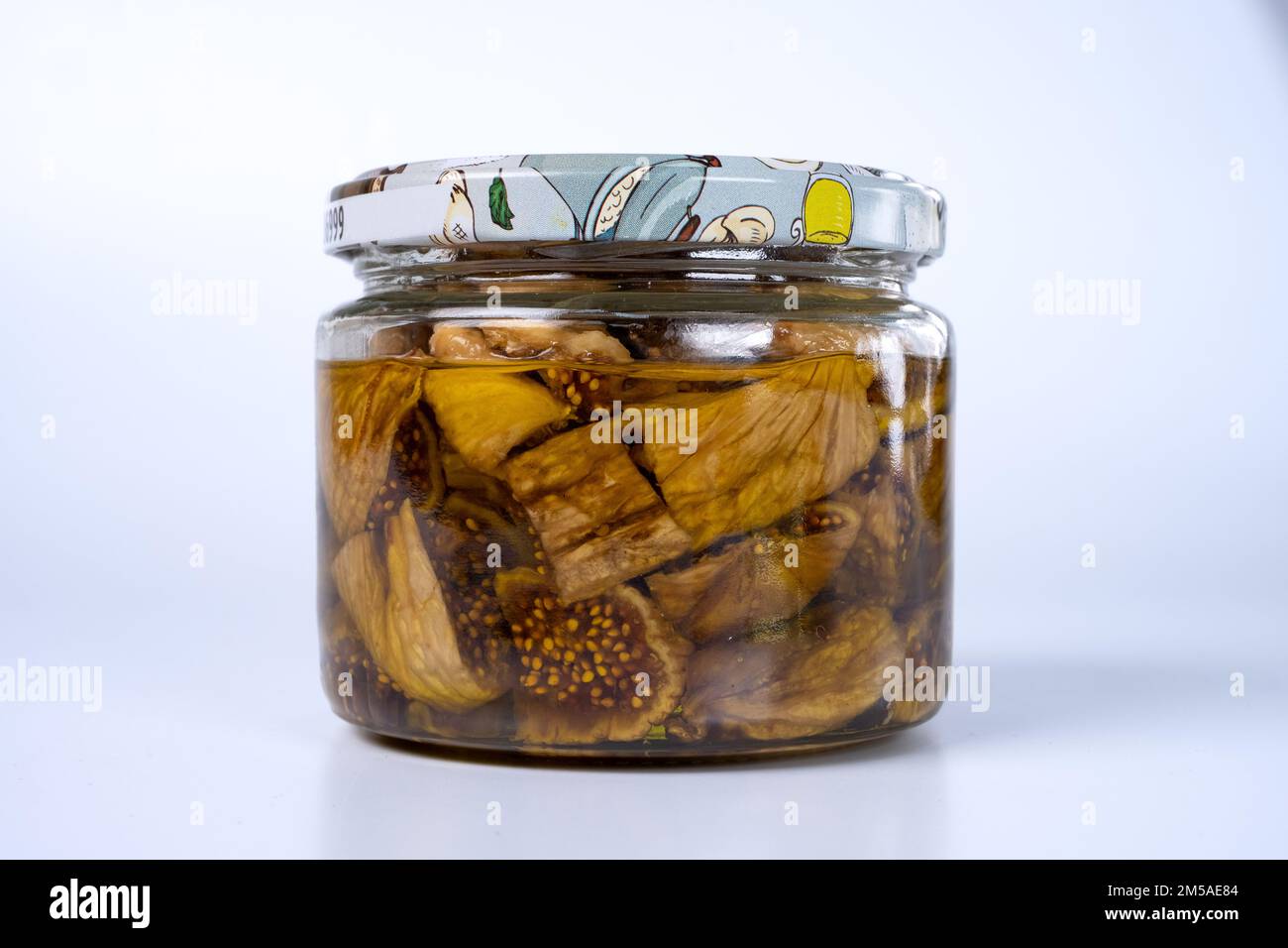 Close up glass jars with dried figs. Homemade fig jam with white ...