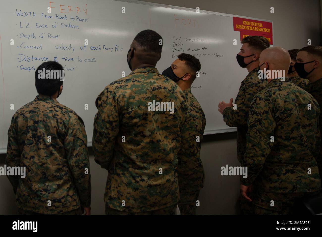 U.S. Marines, with Marine Corps Engineer School, discus class material ...