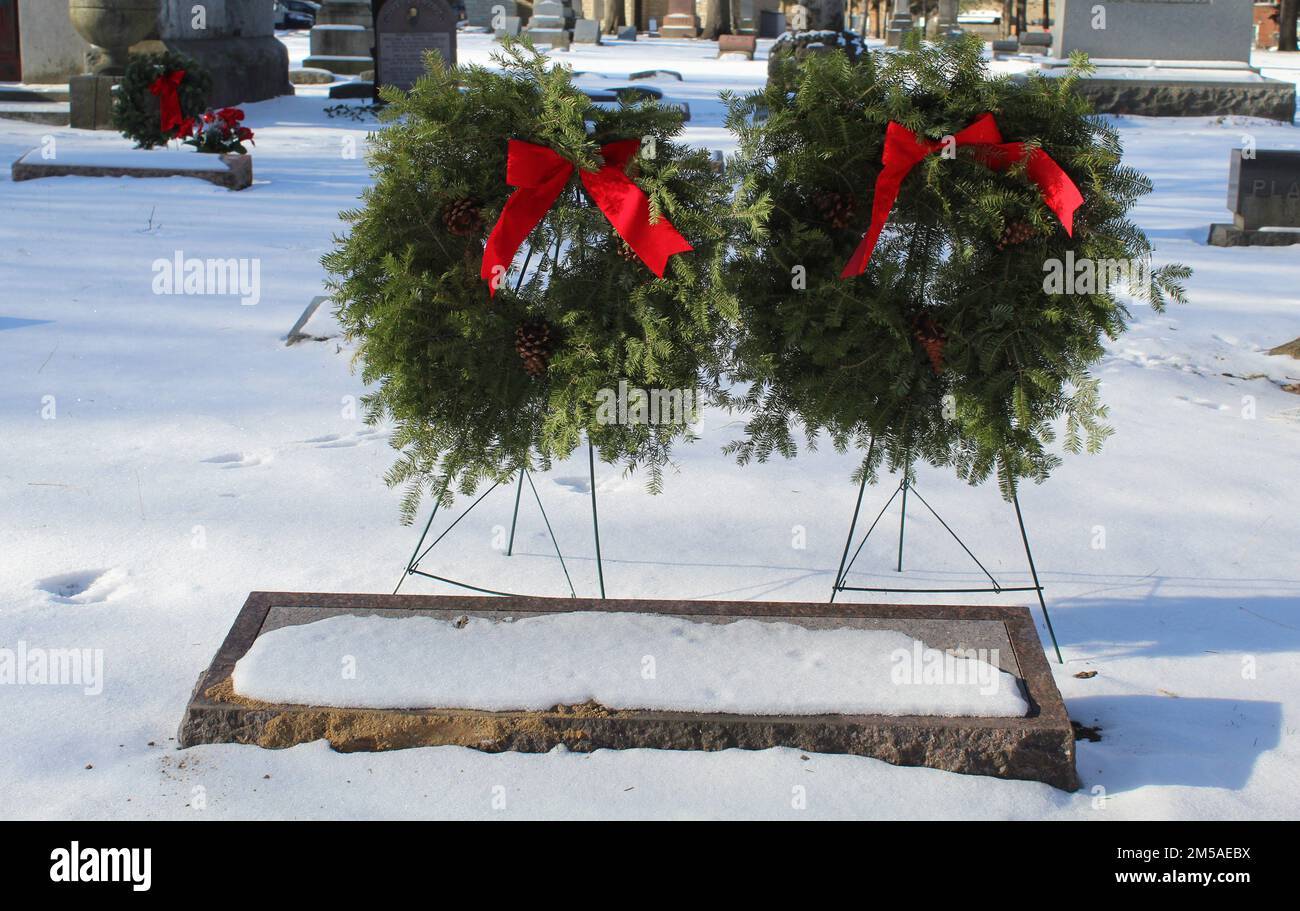 Two Christmas wreaths behind a headstone at a suburban Chicago cemetery ...