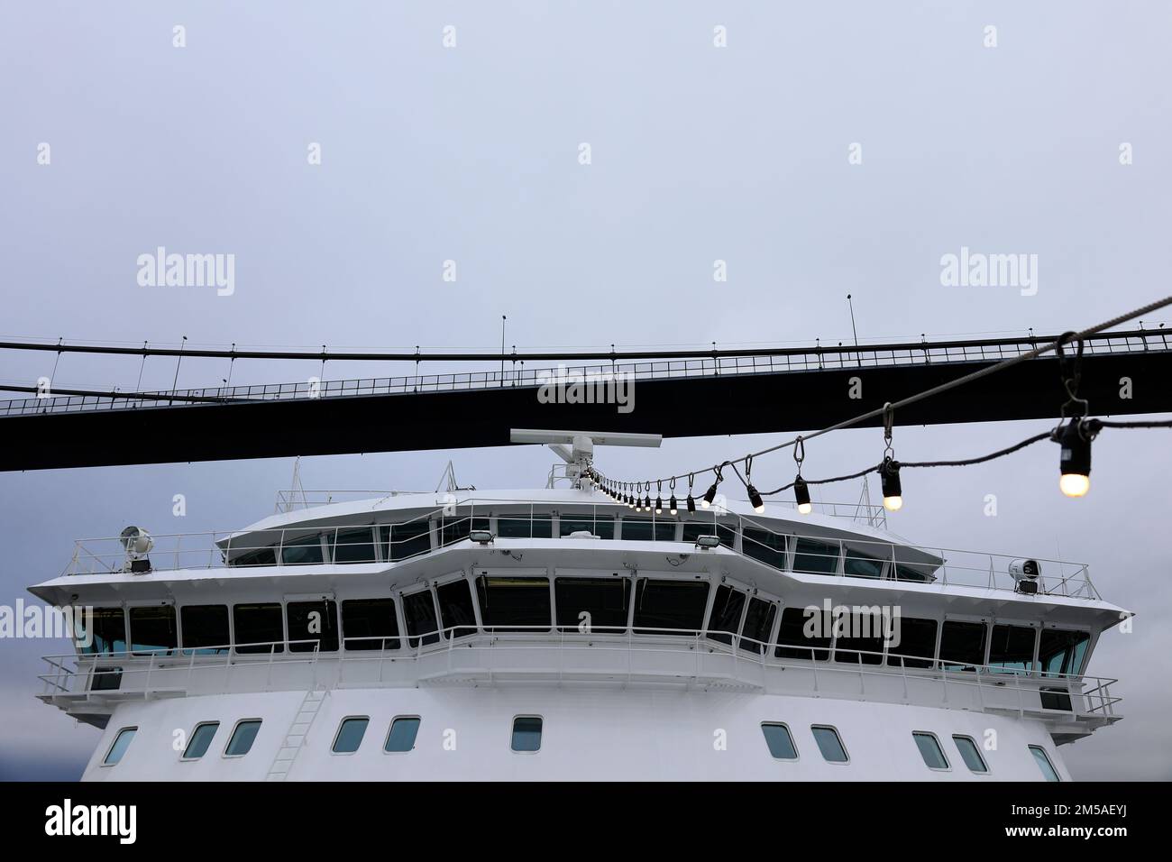 Cruise ship passes under a bridge Stock Photo - Alamy