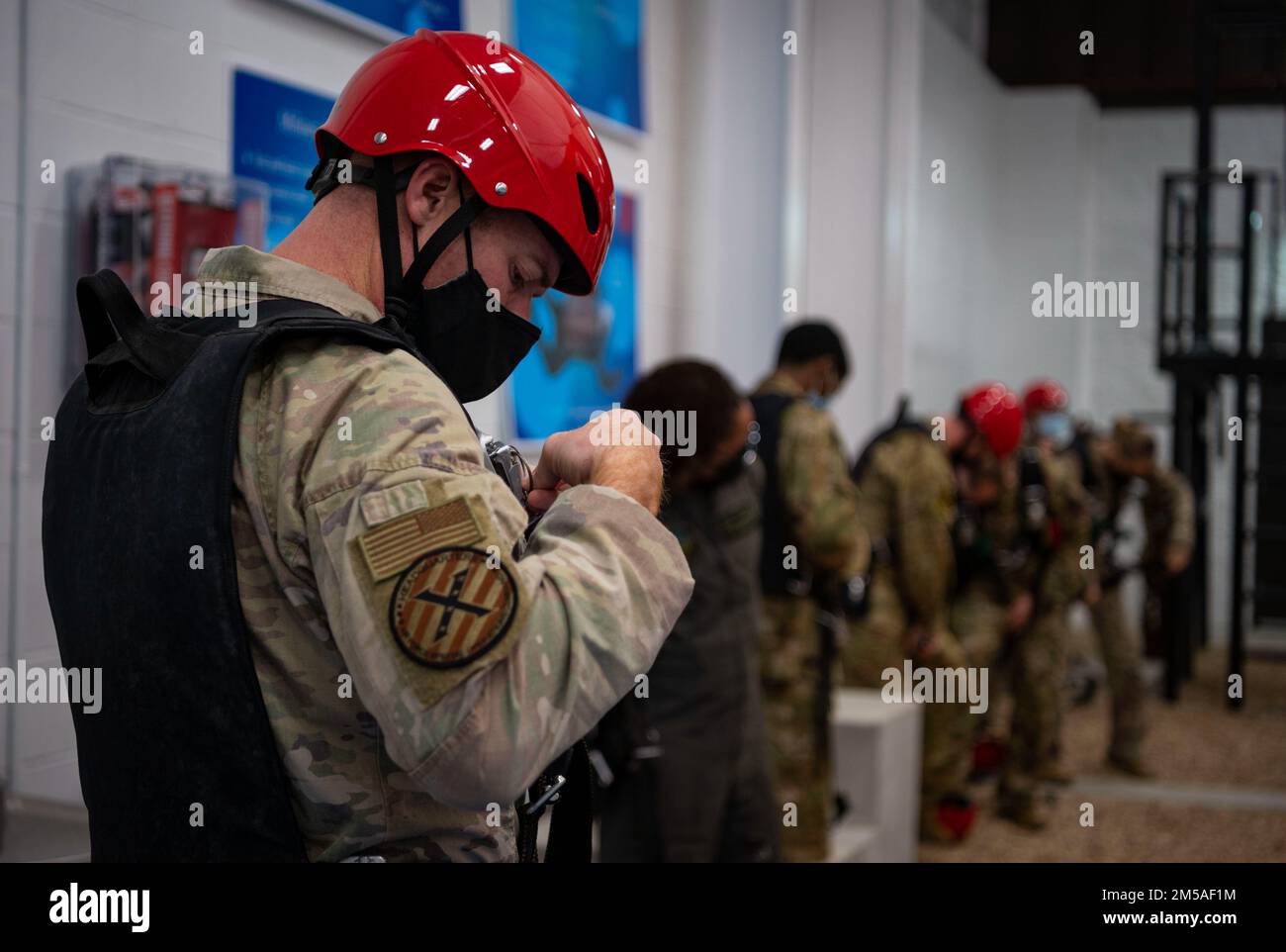 Members of the 1st Special Operations Wing fit a parachute to their ...