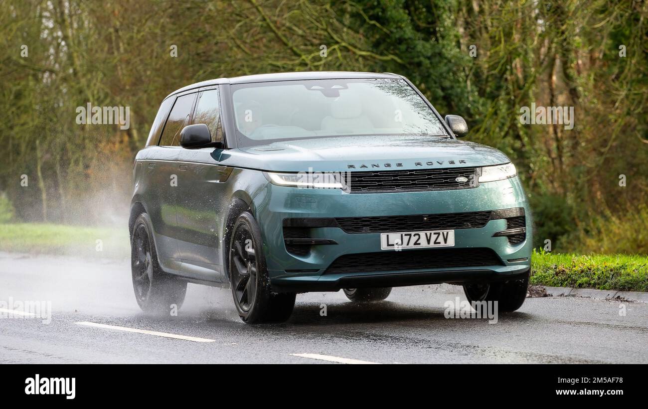 2022 green Range Rover Sport DYN SE D MHEV A driving on a wet road ...
