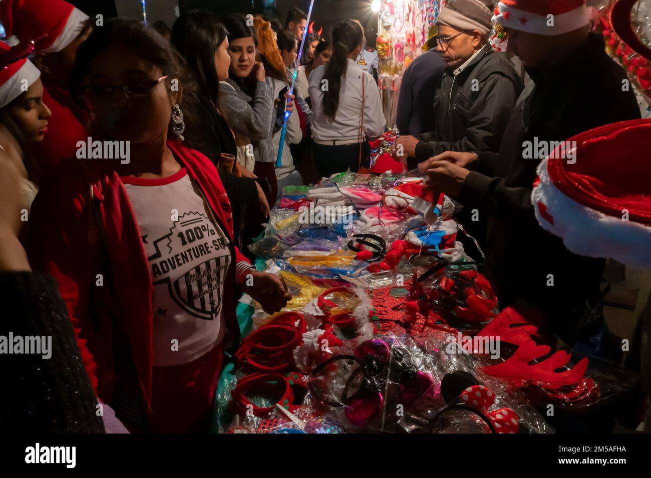 Kolkata, West Bengal, India - 25.12.2018 : Young people buying red hats ...