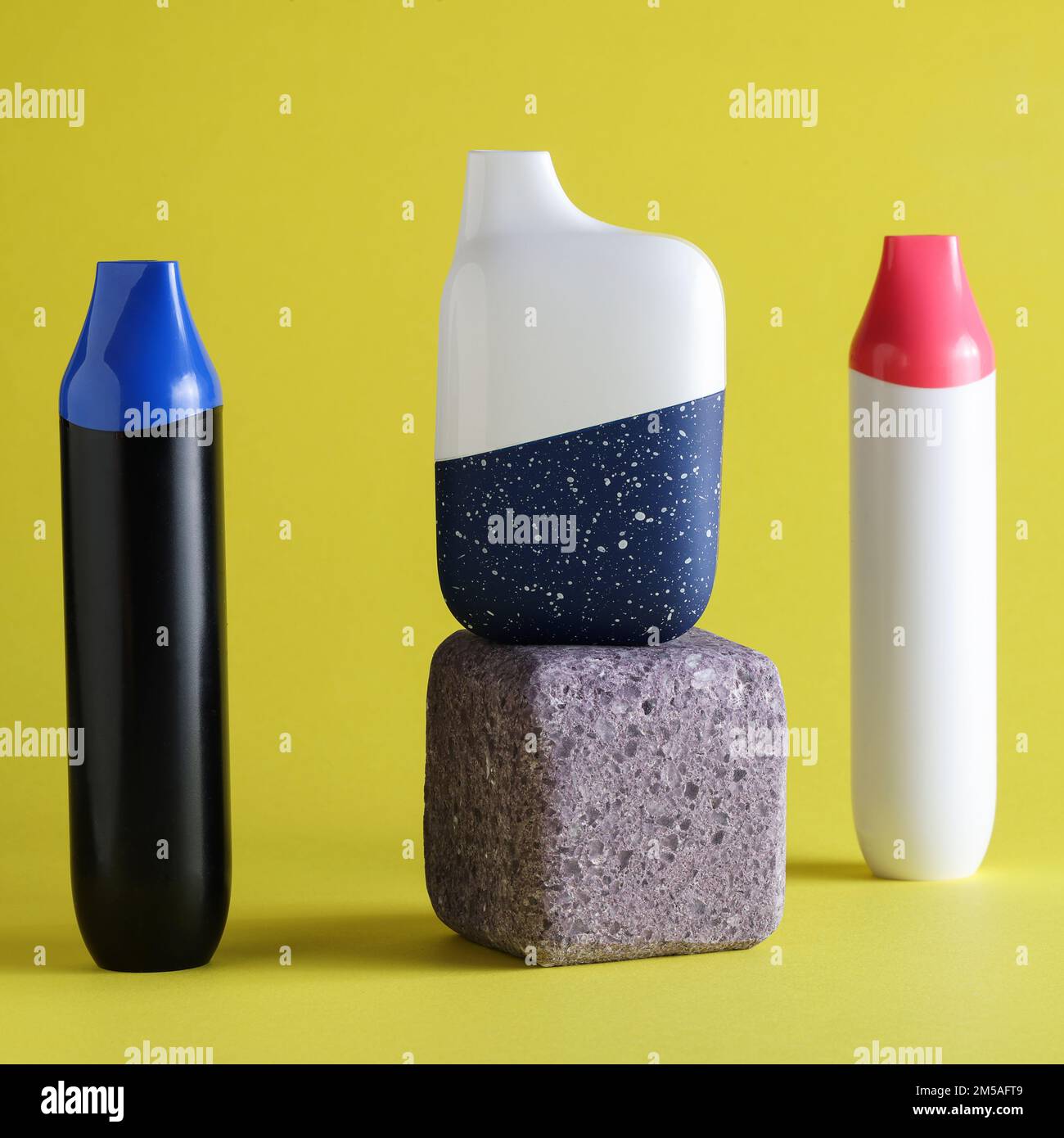 disposable electronic cigarettes or vapes on yellow background. copy ...