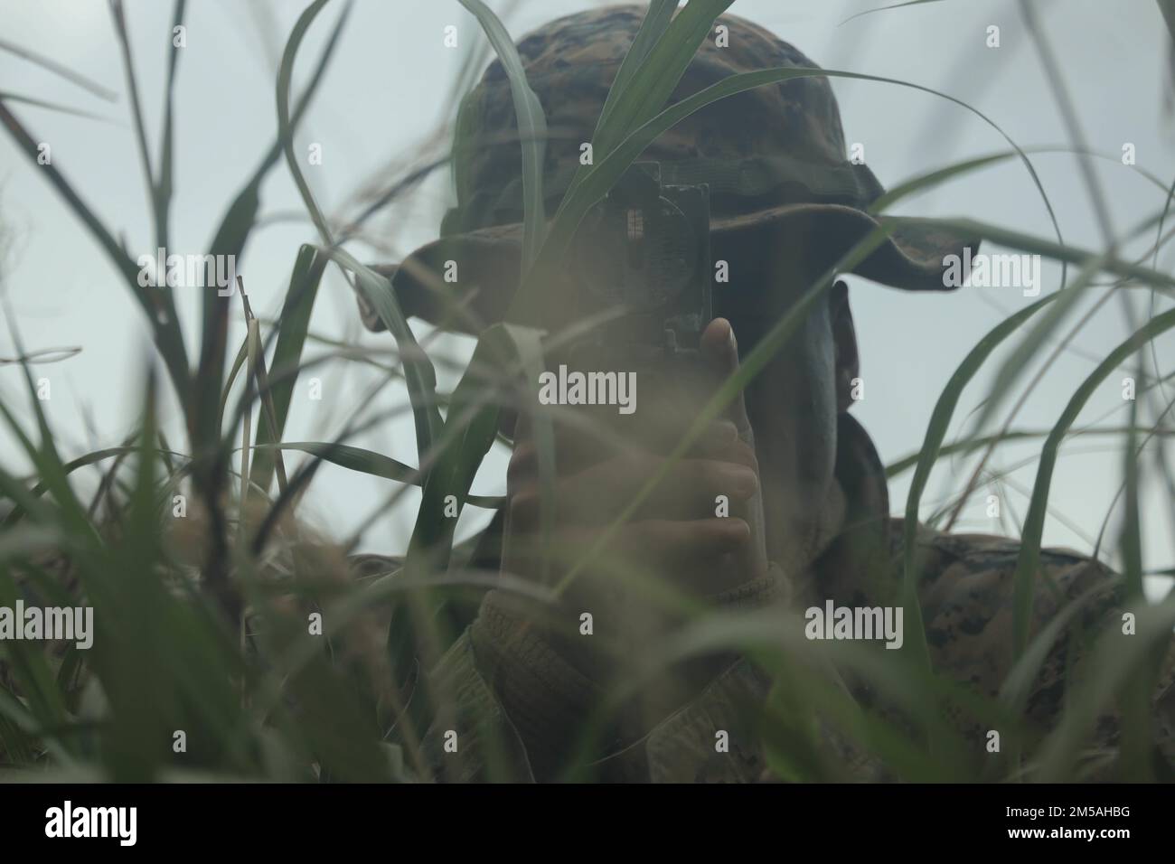 A U.S. Marine with 2d Battalion, 7th Marines, checks the alignment of ...