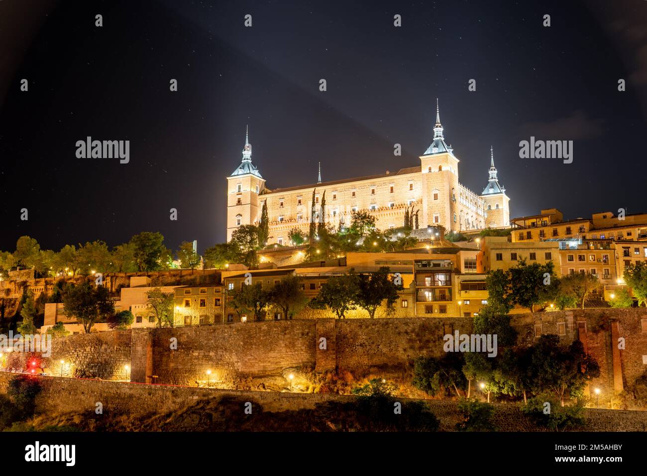 Toledo downtown lights with Alcazar castle on top Stock Photo - Alamy
