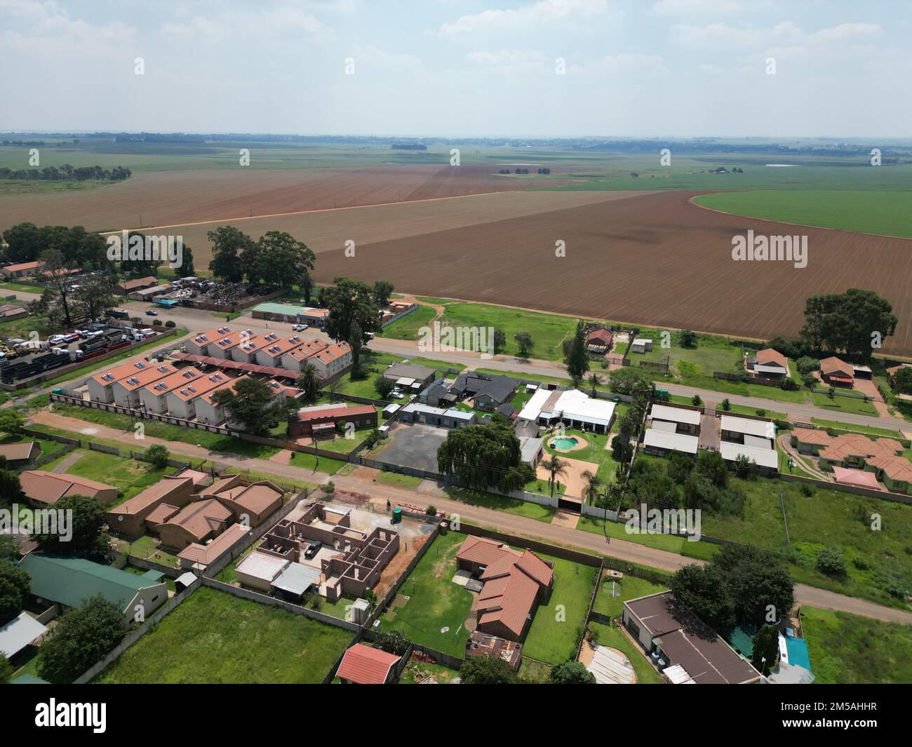 An aerial view of a residential area with vast agricultural lands in ...