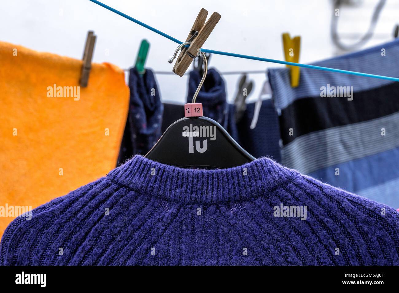 Clothes hanging on washing line Stock Photo - Alamy