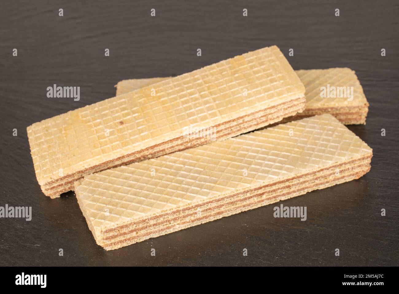 Three sweet chocolate wafers on a slate stone, close-up Stock Photo - Alamy