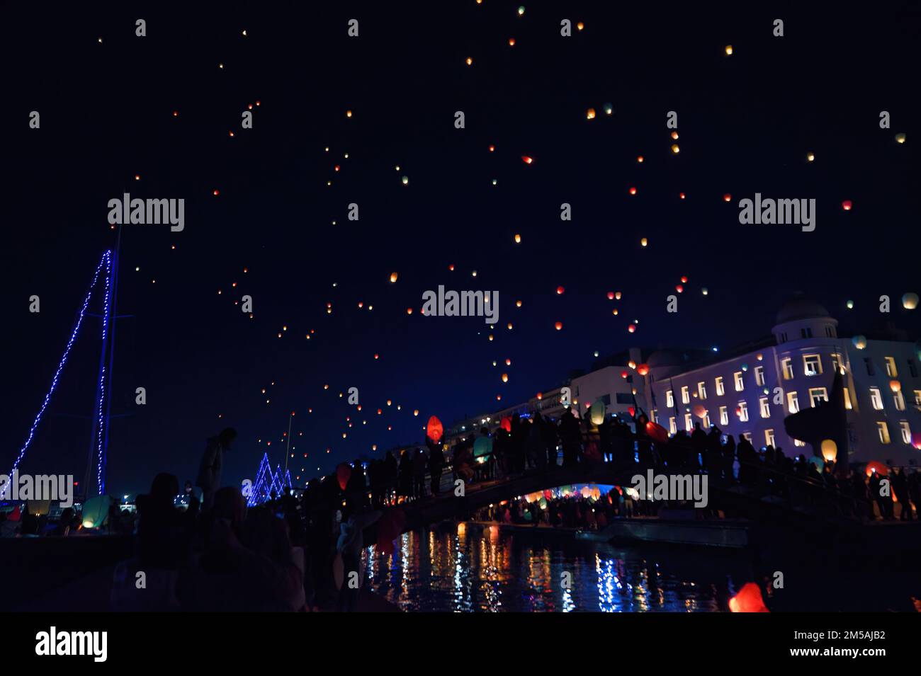 A magical scene of sparkling sky lanterns floating in the night in ...