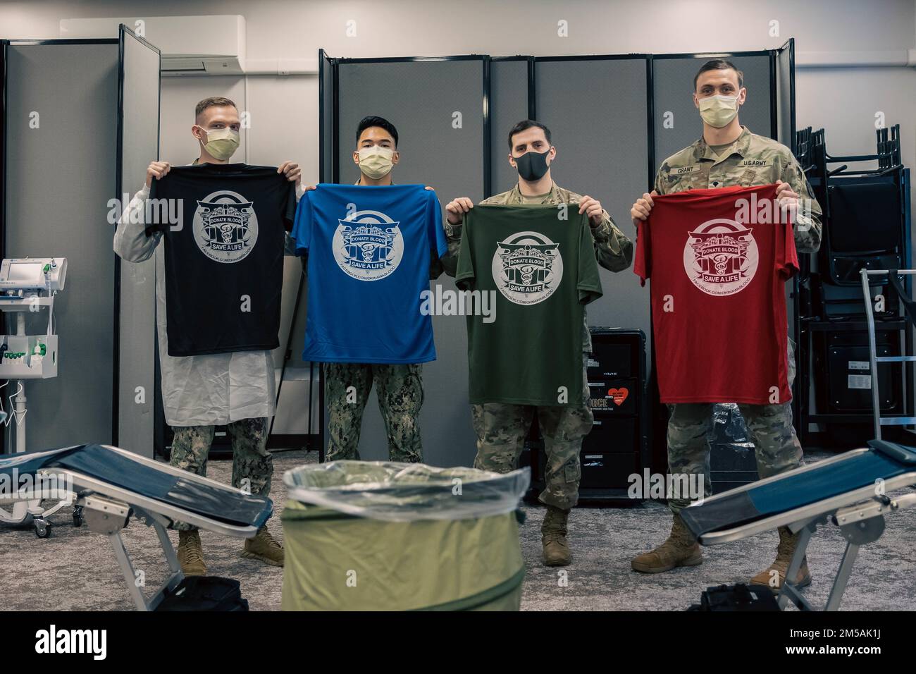 U.S. service members pose for a photo during a blood drive on Camp ...
