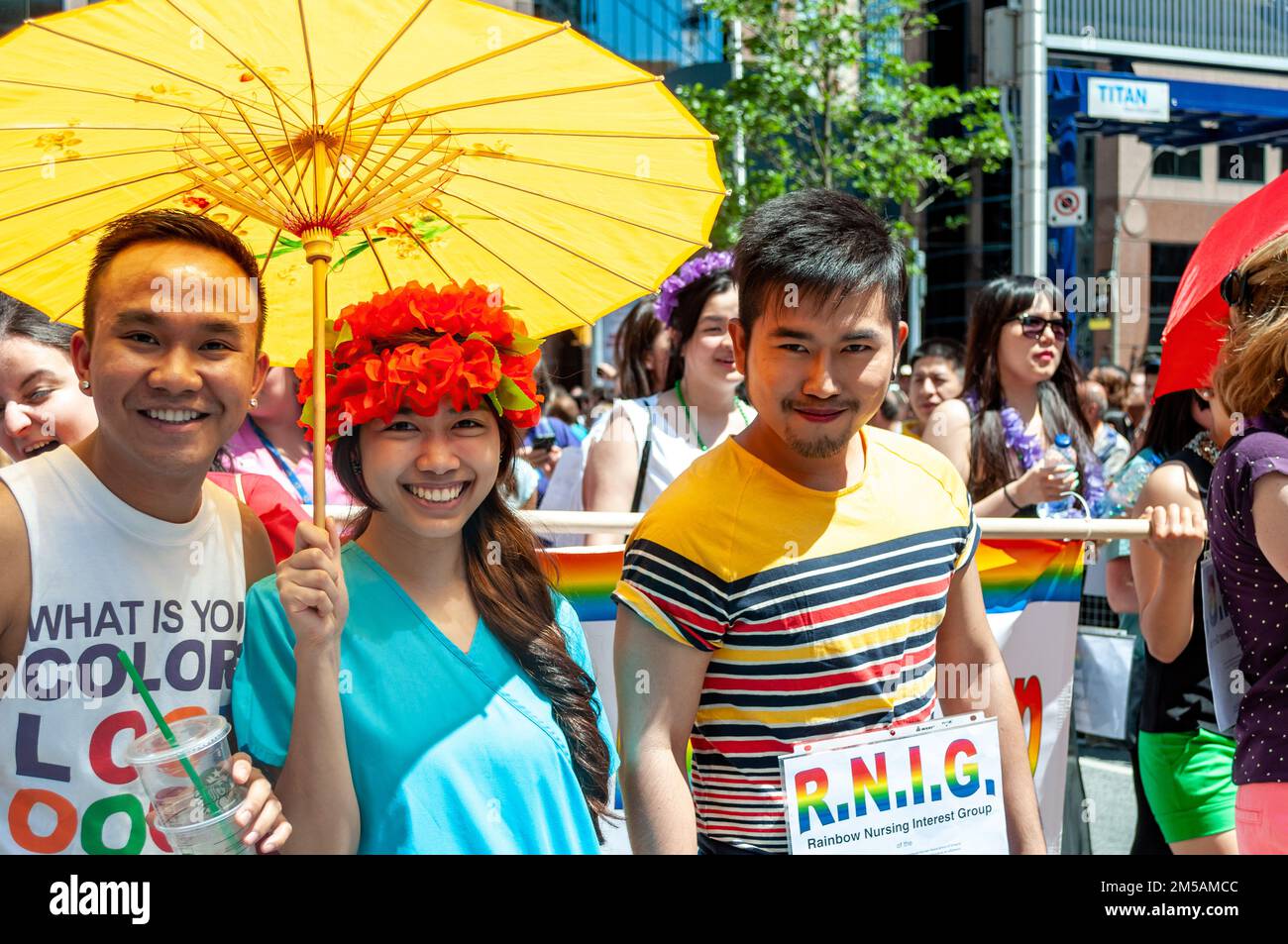 Portrait of three people of Asian descent. They are marching with a ...