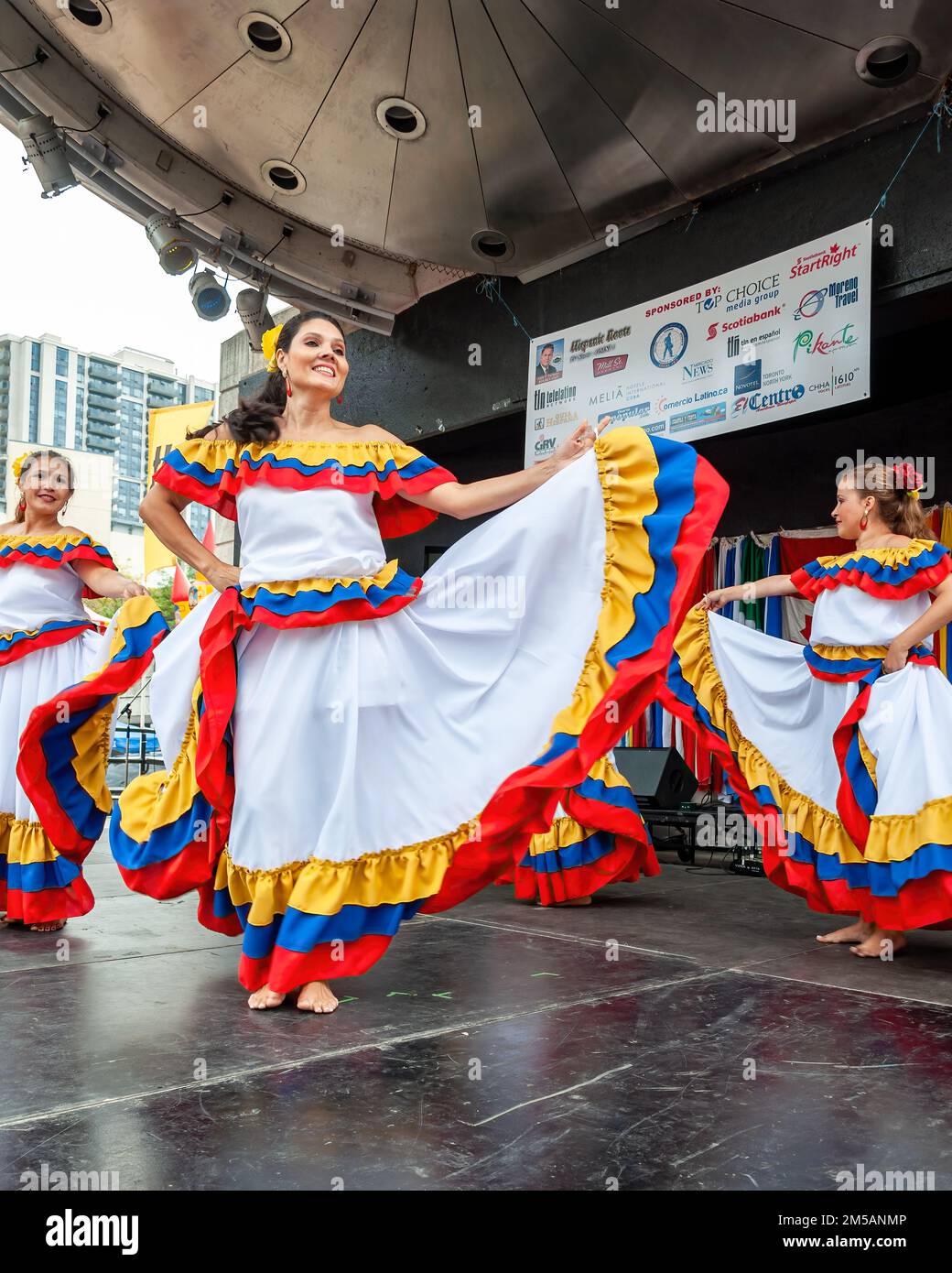 A group of Colombian women wearing traditional clothes dance in the ...