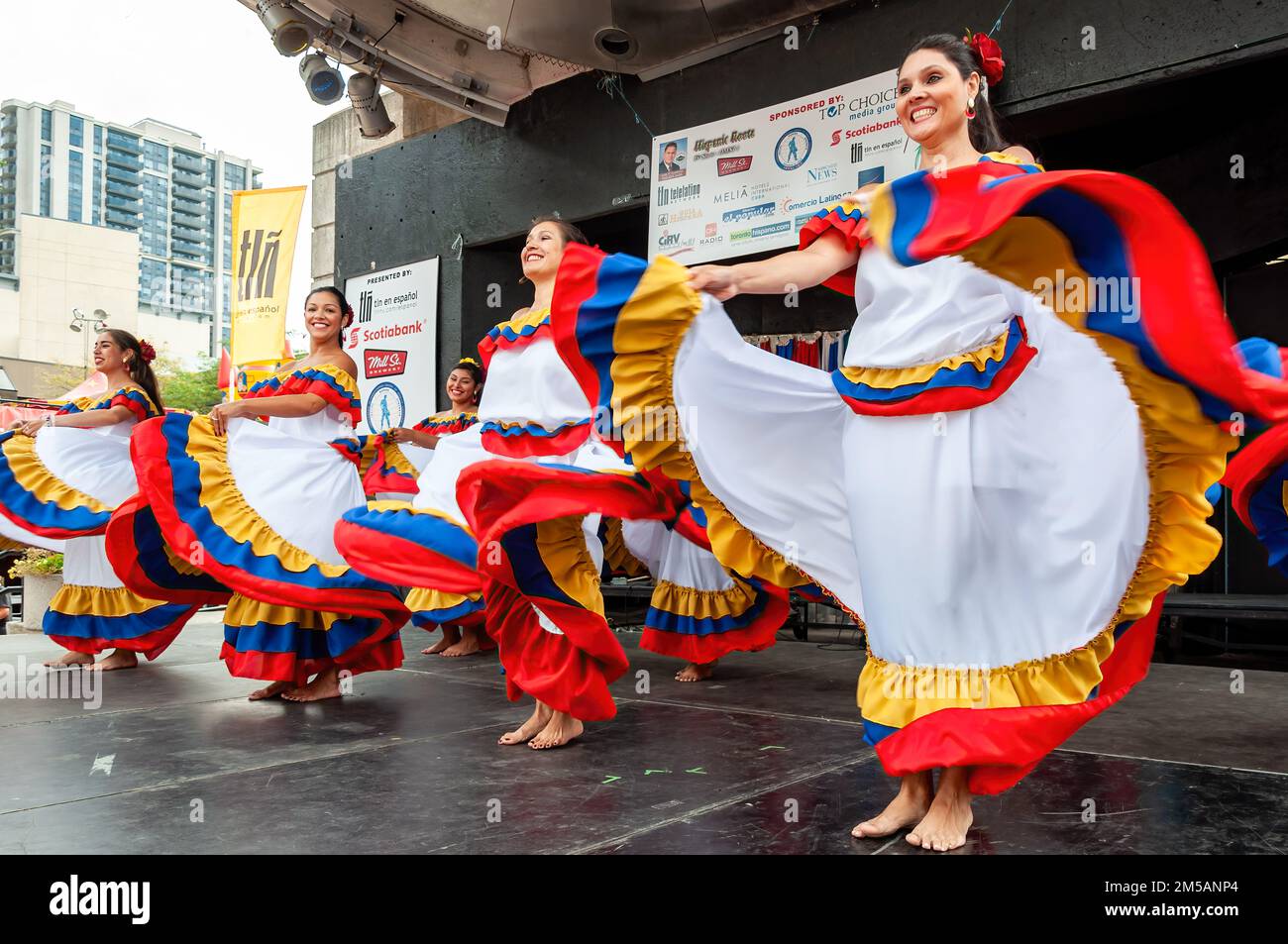 A group of Colombian women wearing traditional clothes dance in the ...