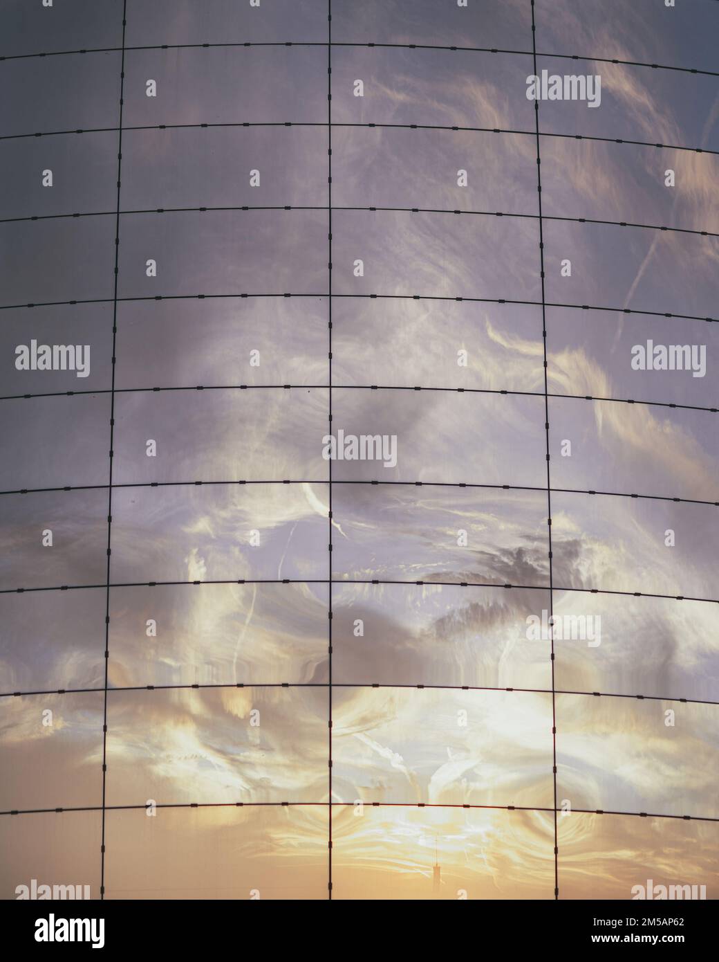 the glass exterior of a building reflecting skies and clouds Stock ...