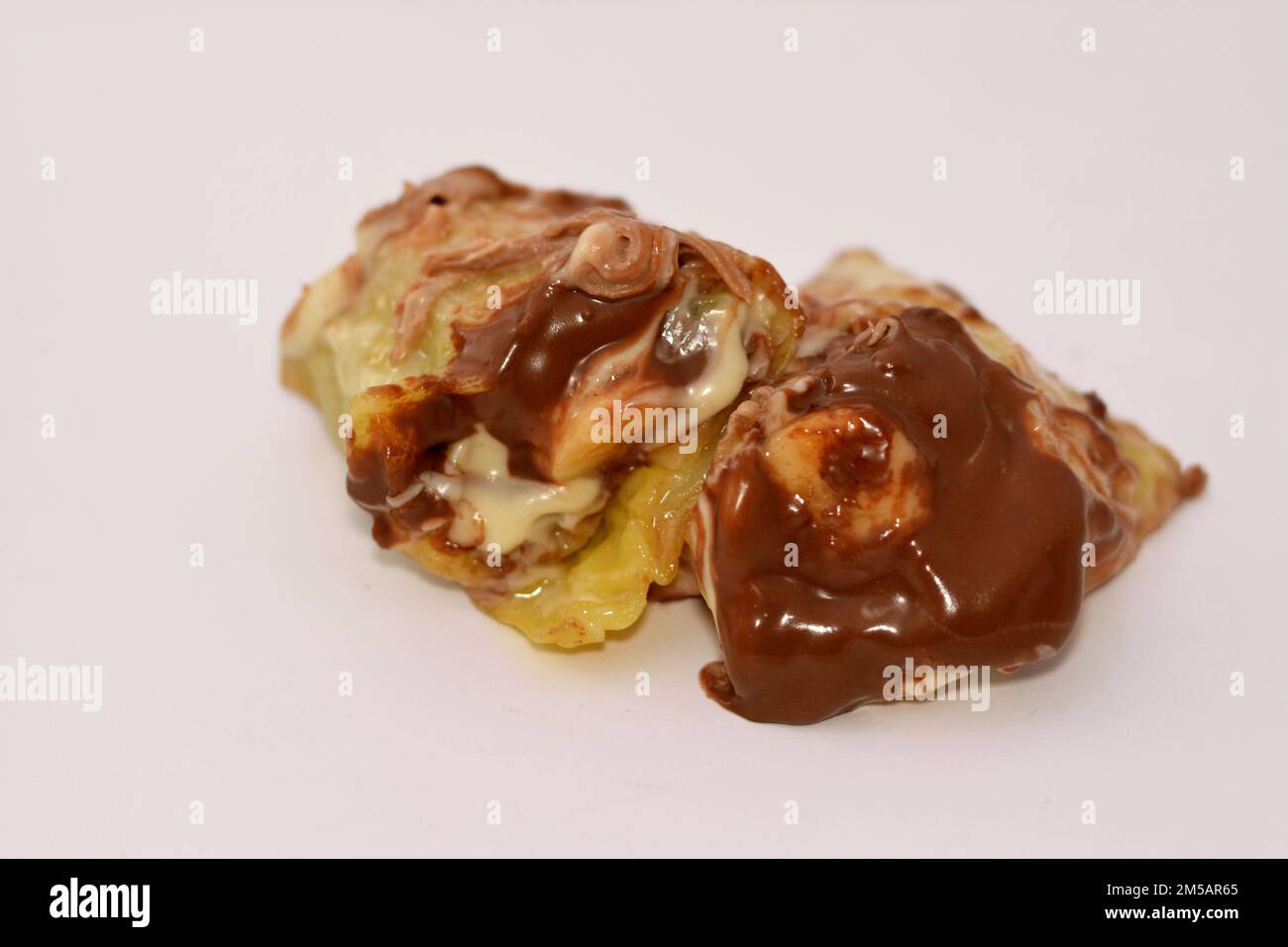 Sweet chocolate mix rolls stuffed with banana fruit pieces, nuts ...