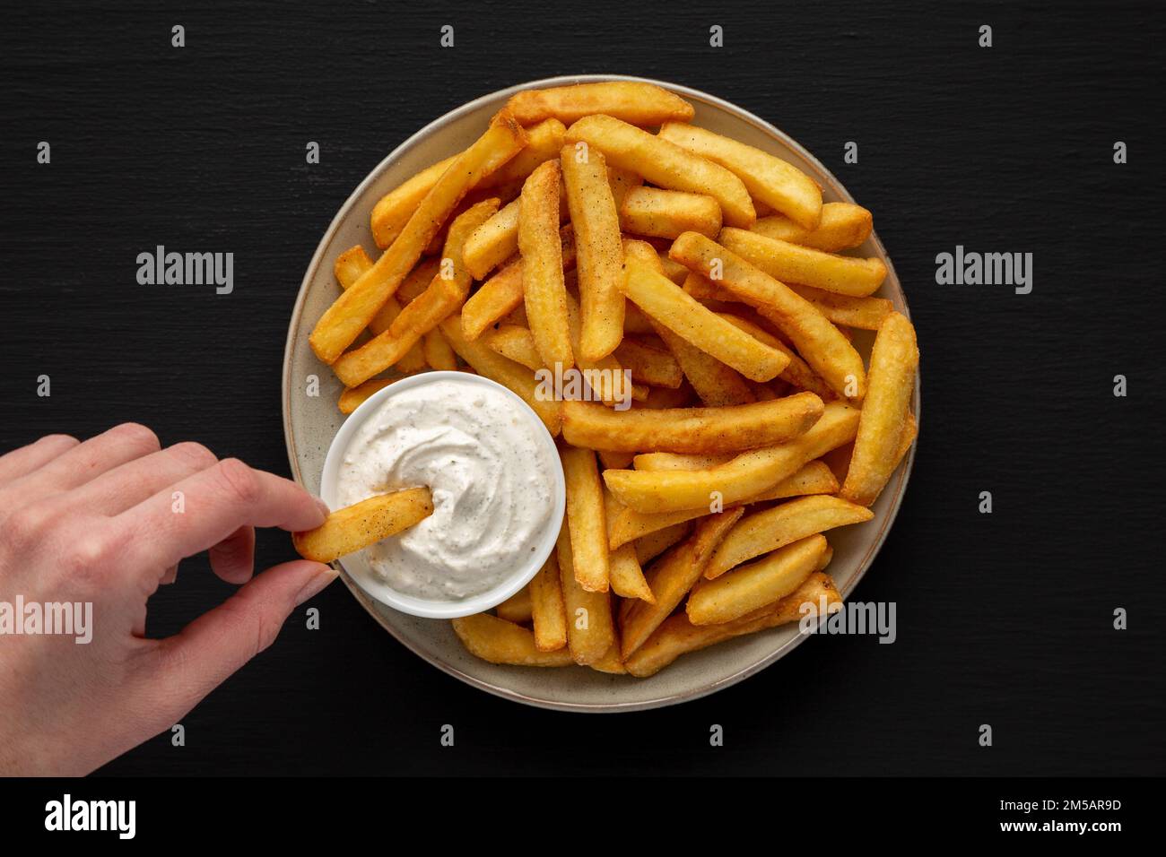 Hand takes French Fries with Ranch Dressing, top view Stock Photo - Alamy