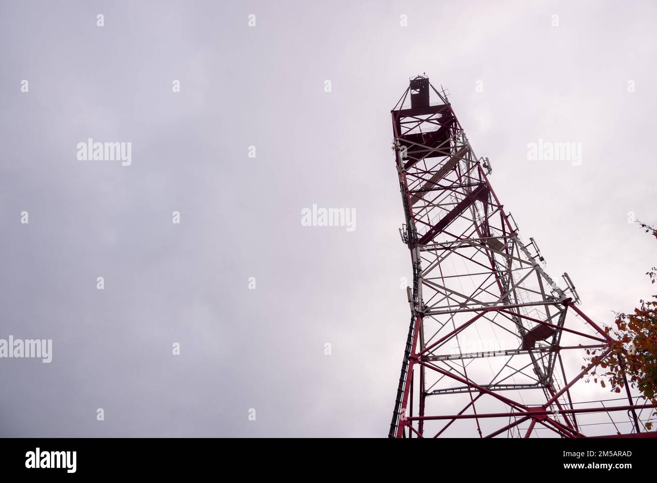 An old television and radio tower in faded colors looks vertically at ...