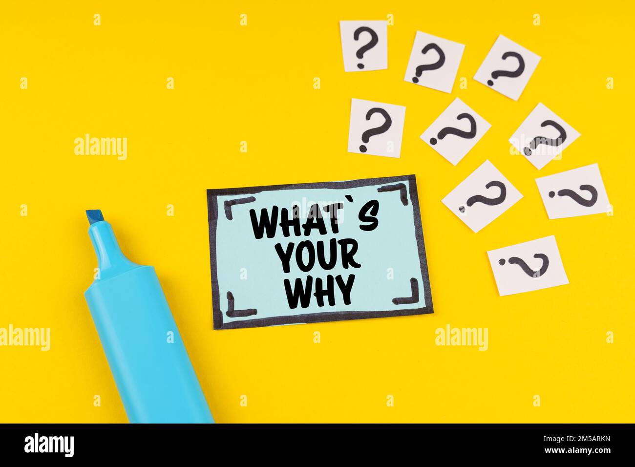 Business concept. On the yellow surface lies a blue marker, question ...
