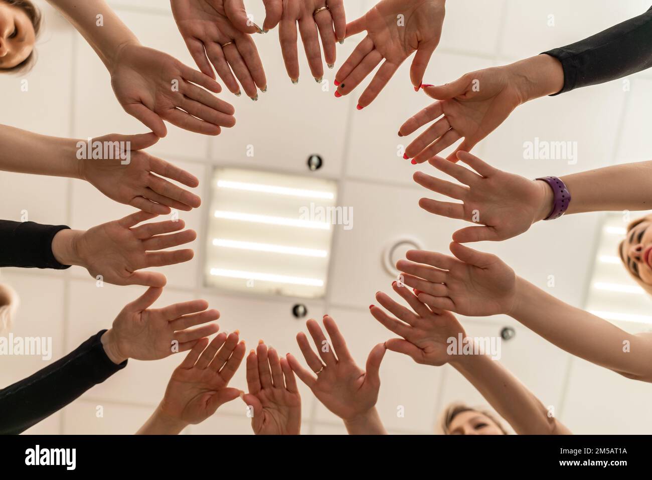 Team of people holding hands. Group of happy young women holding hands ...