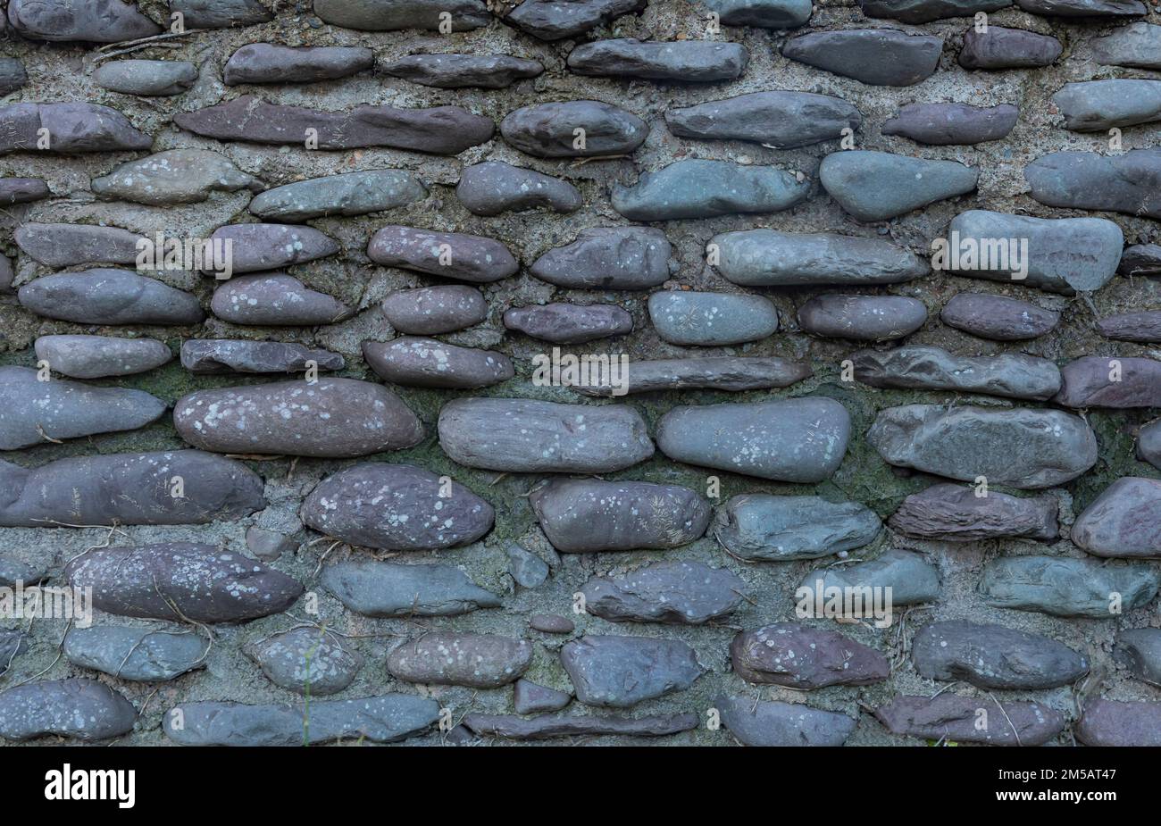 Background of an old stone wall made out of large rocks which look ...