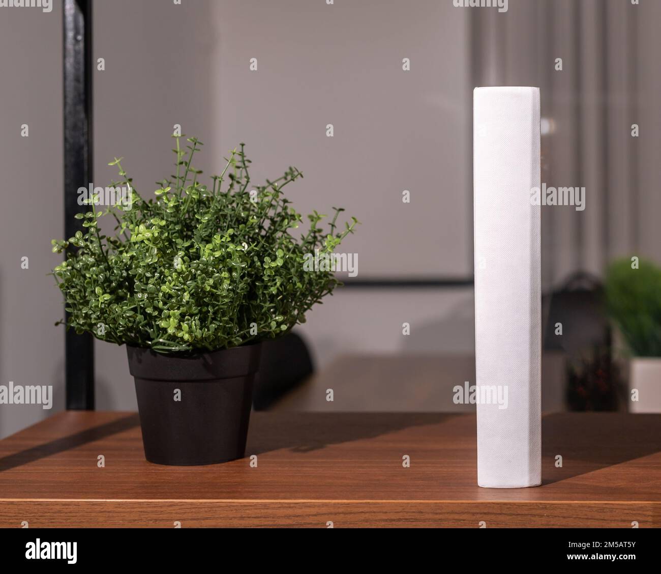 Paper book spine in hard cover mockup on wood shelf in modern loft ...