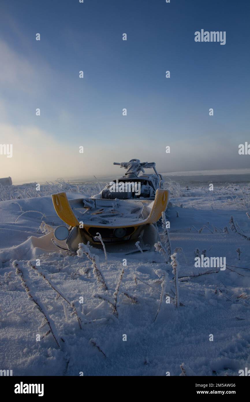 Old snowmobile sitting on a snow covered landscape, near Churchill ...