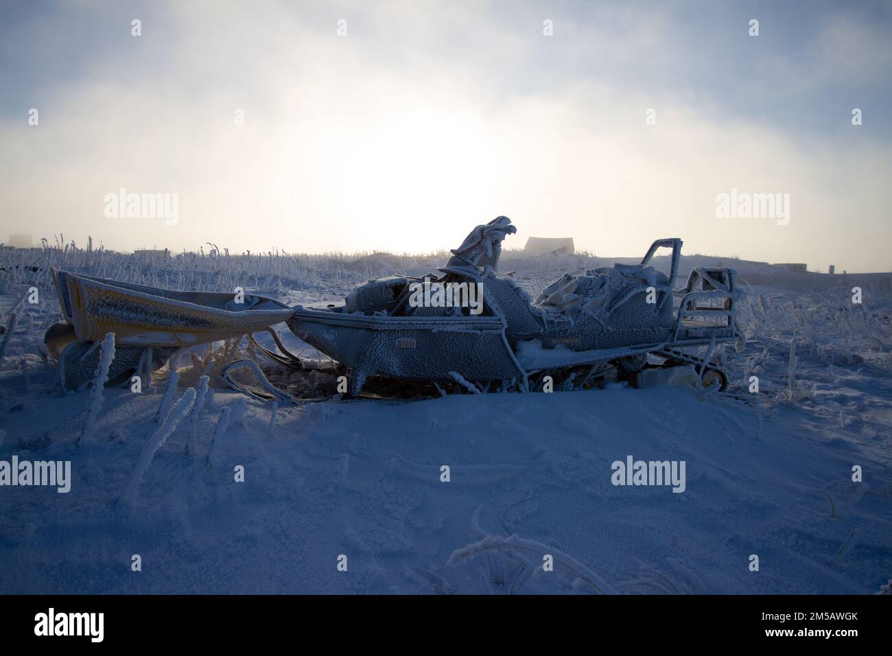 Old snowmobile sitting on a snow covered landscape, near Churchill ...