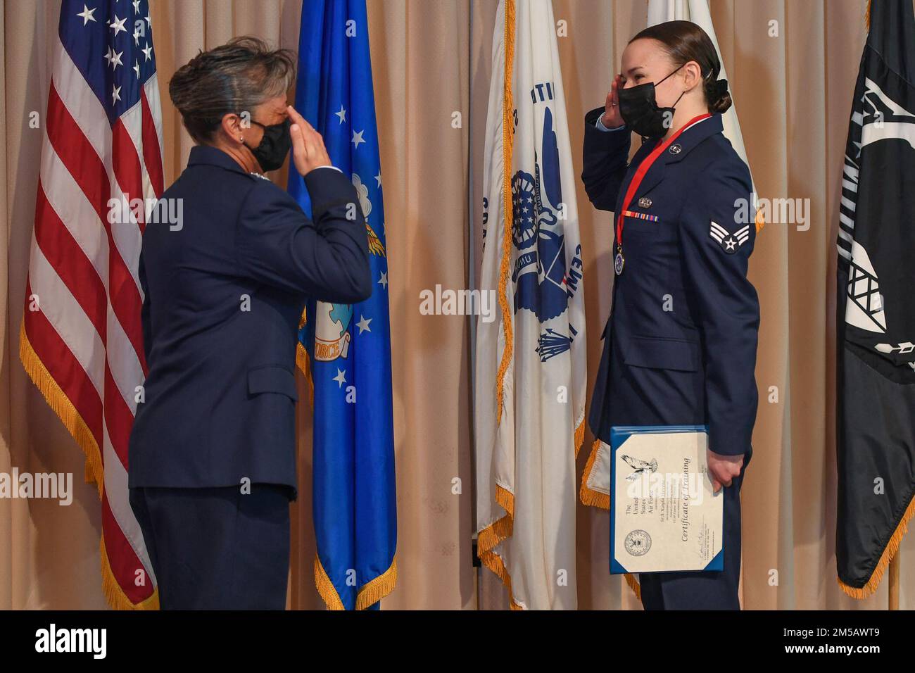 Col. Katrina Stephens, left, 66th Air Base Group commander, returns a ...