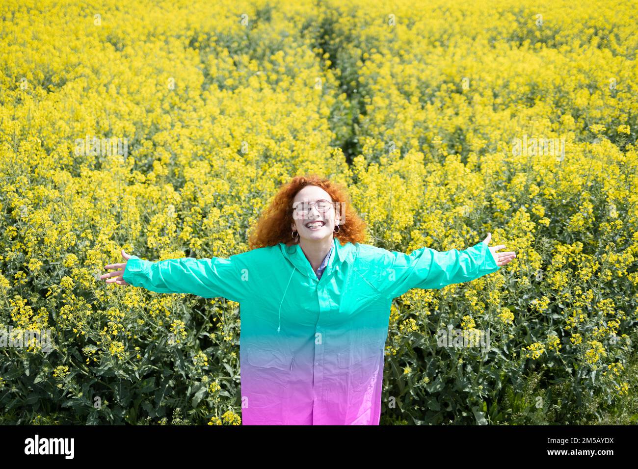 A woman i a colorful raincoat enjoying her day. International womens ...