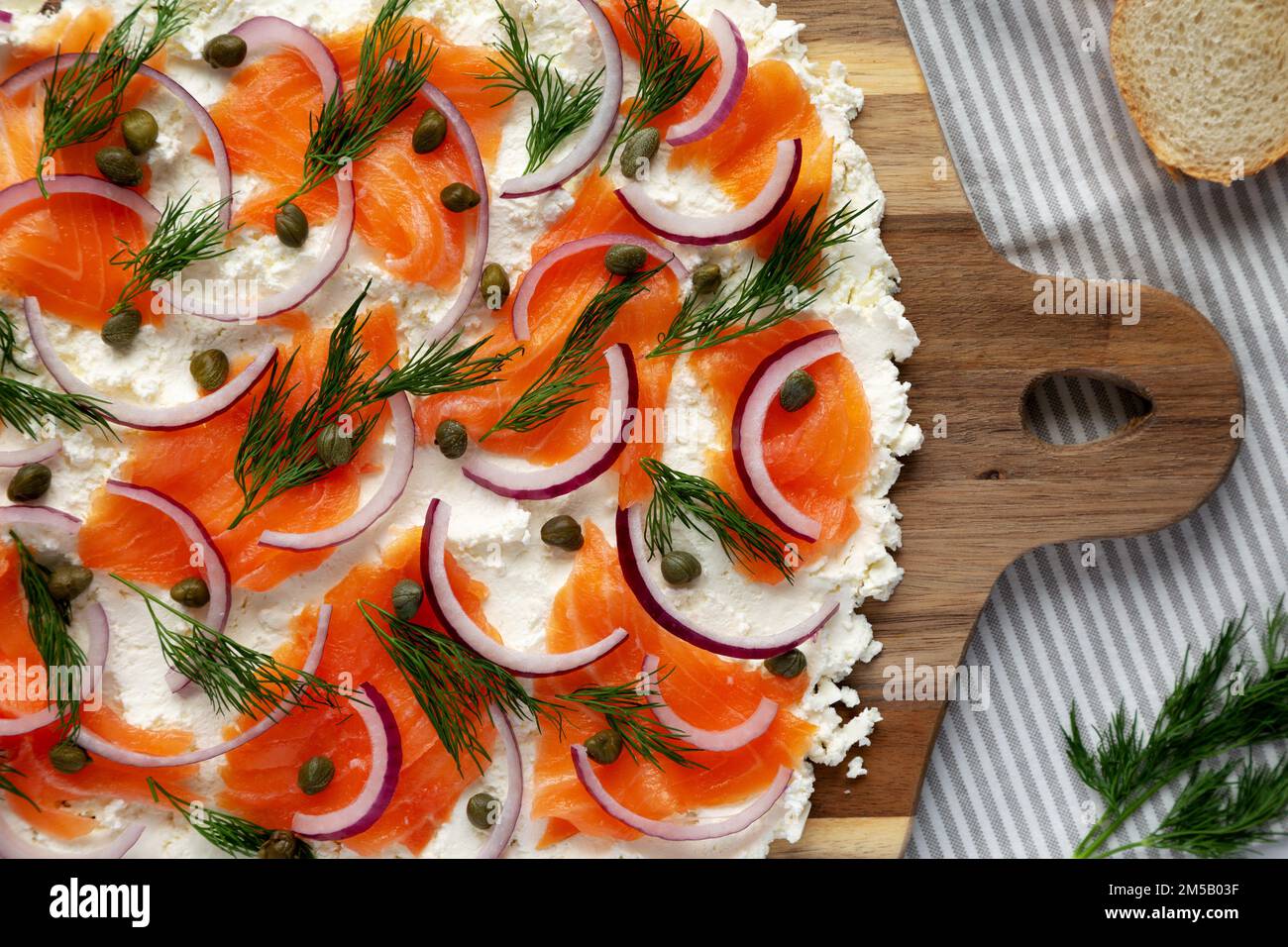 Homemade Cream Cheese Lox Bagel Board with Salmon on a white wooden ...