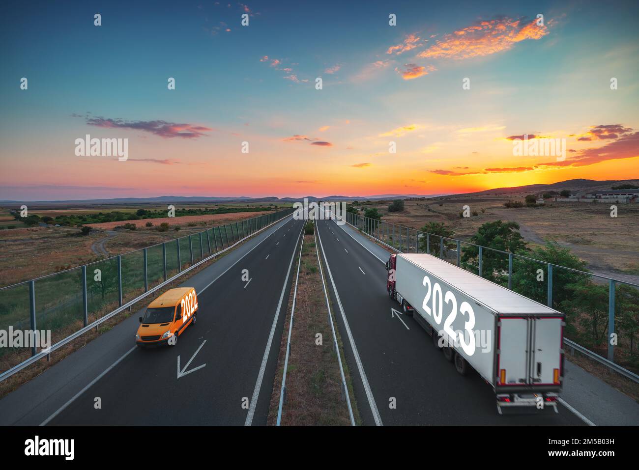 Driving on open road at beautiful sunset toward upcoming new year 2023 ...