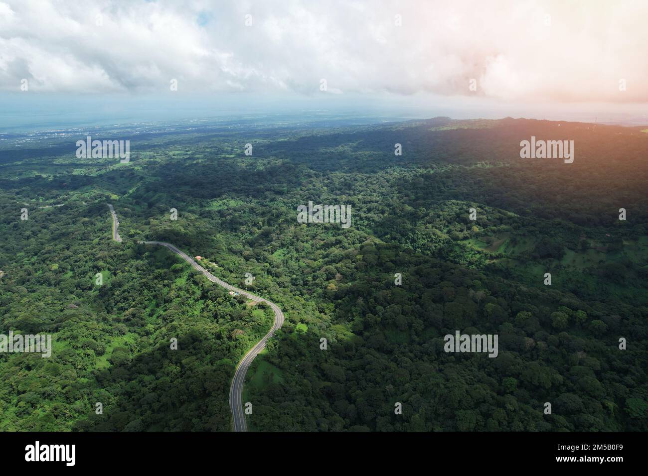 Curvy asphalt road in mountain background aerial drone view Stock Photo ...