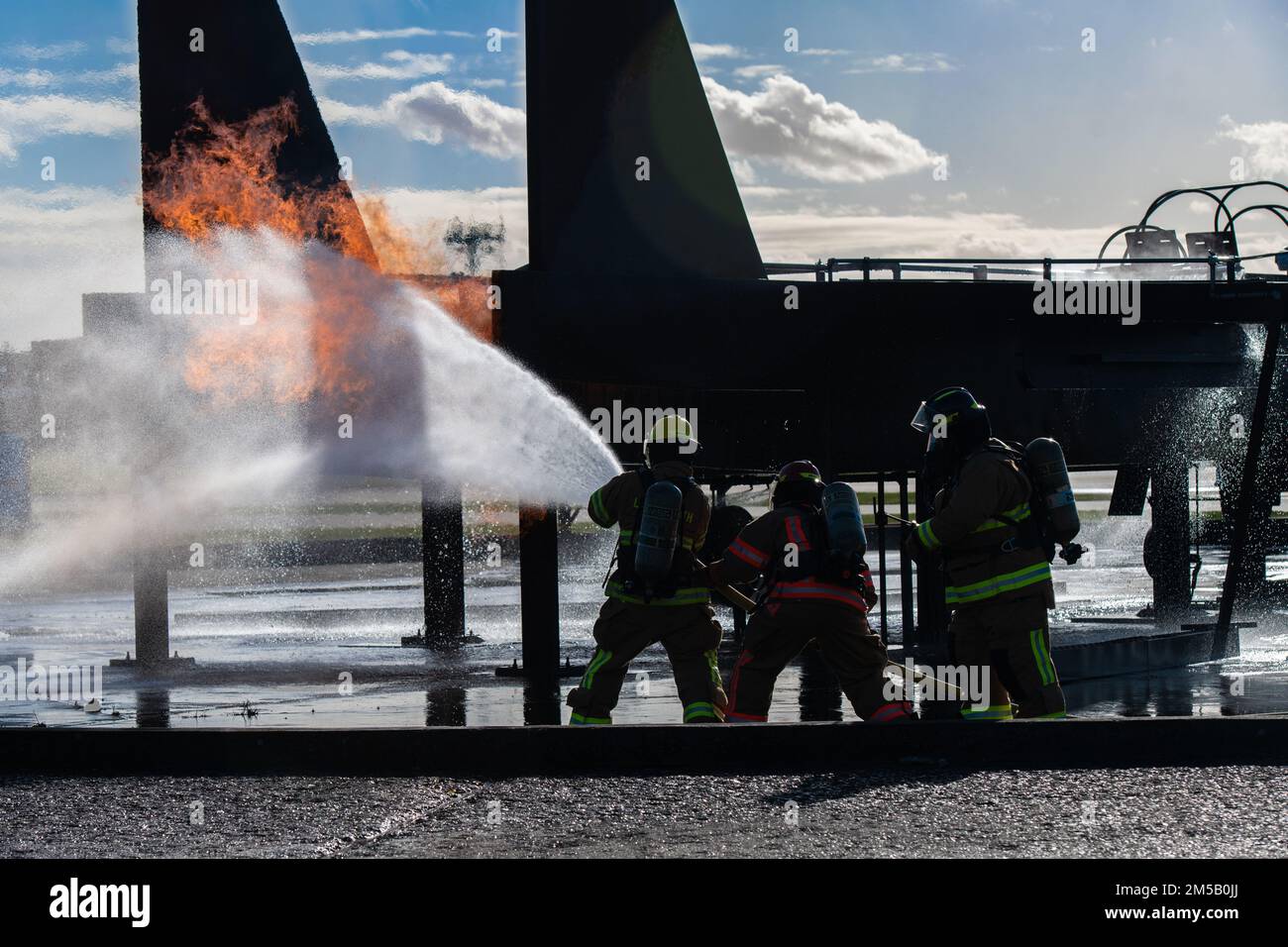 Firefighters from the 48th Civil Engineer Squadron begin putting out an ...