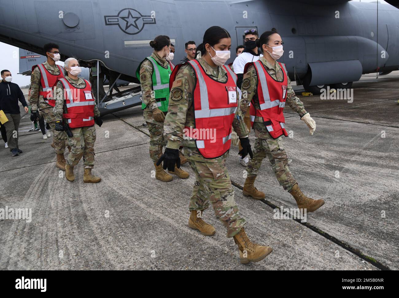 Members of the 81st Medical Group lead patients toward the triage area ...
