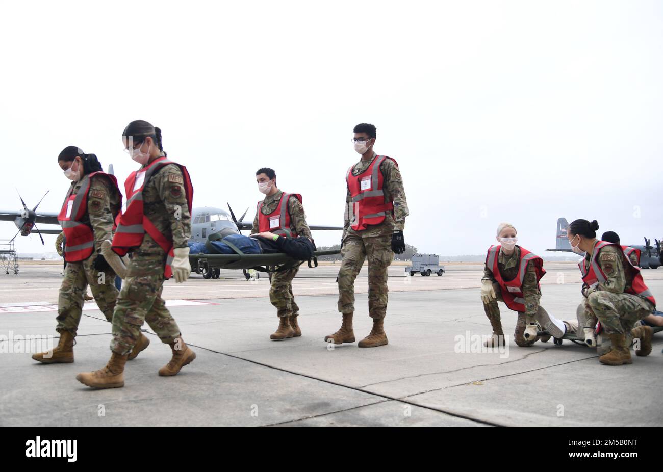 Members of the 81st Medical Group carry patients to the triage area for ...