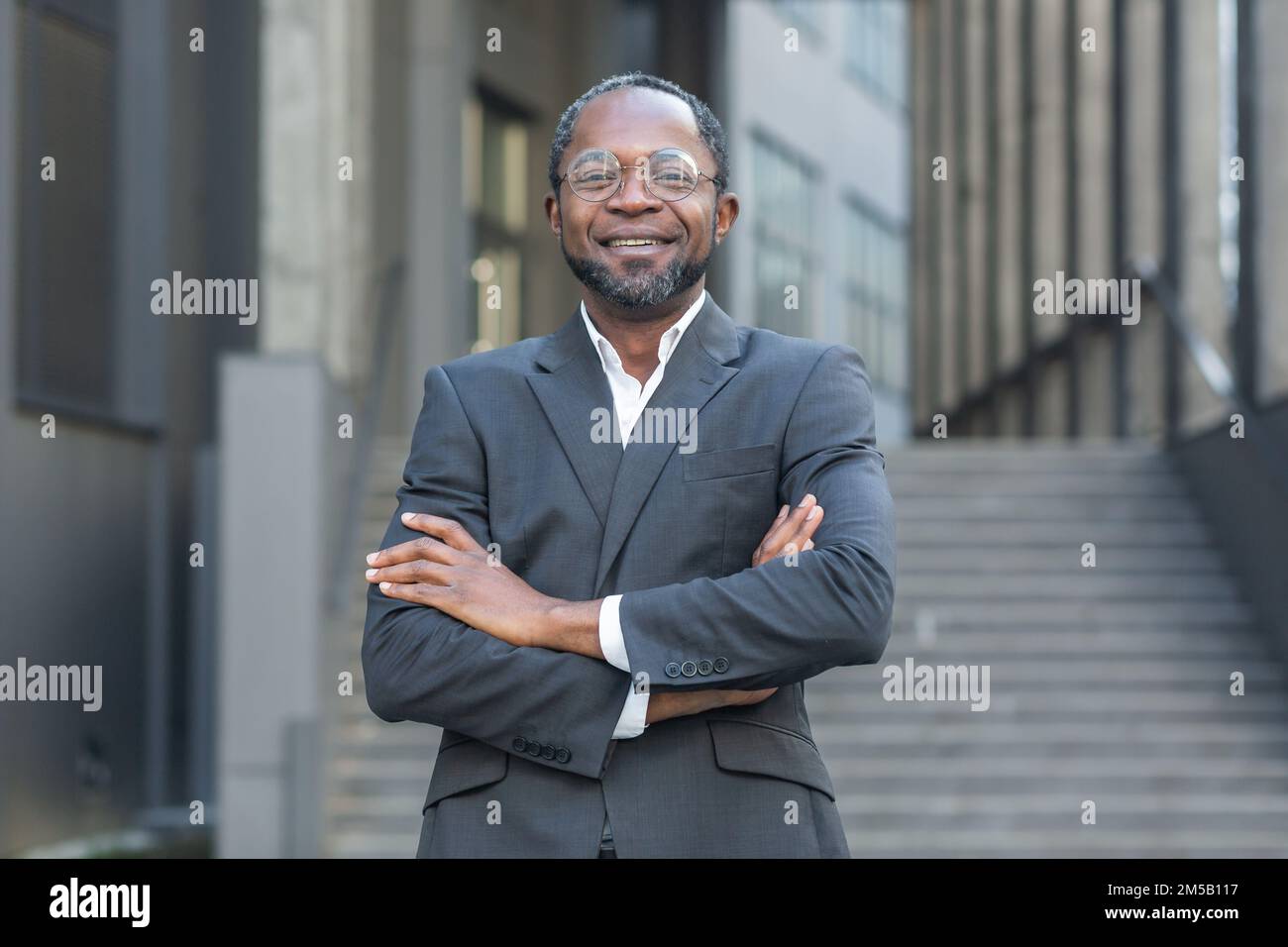 Successful african american boss with arms crossed smiling and looking ...