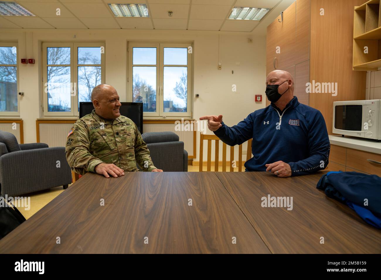 Lt. Col. Miguel Cisneros (left) chats with Grant McCormick, regional ...