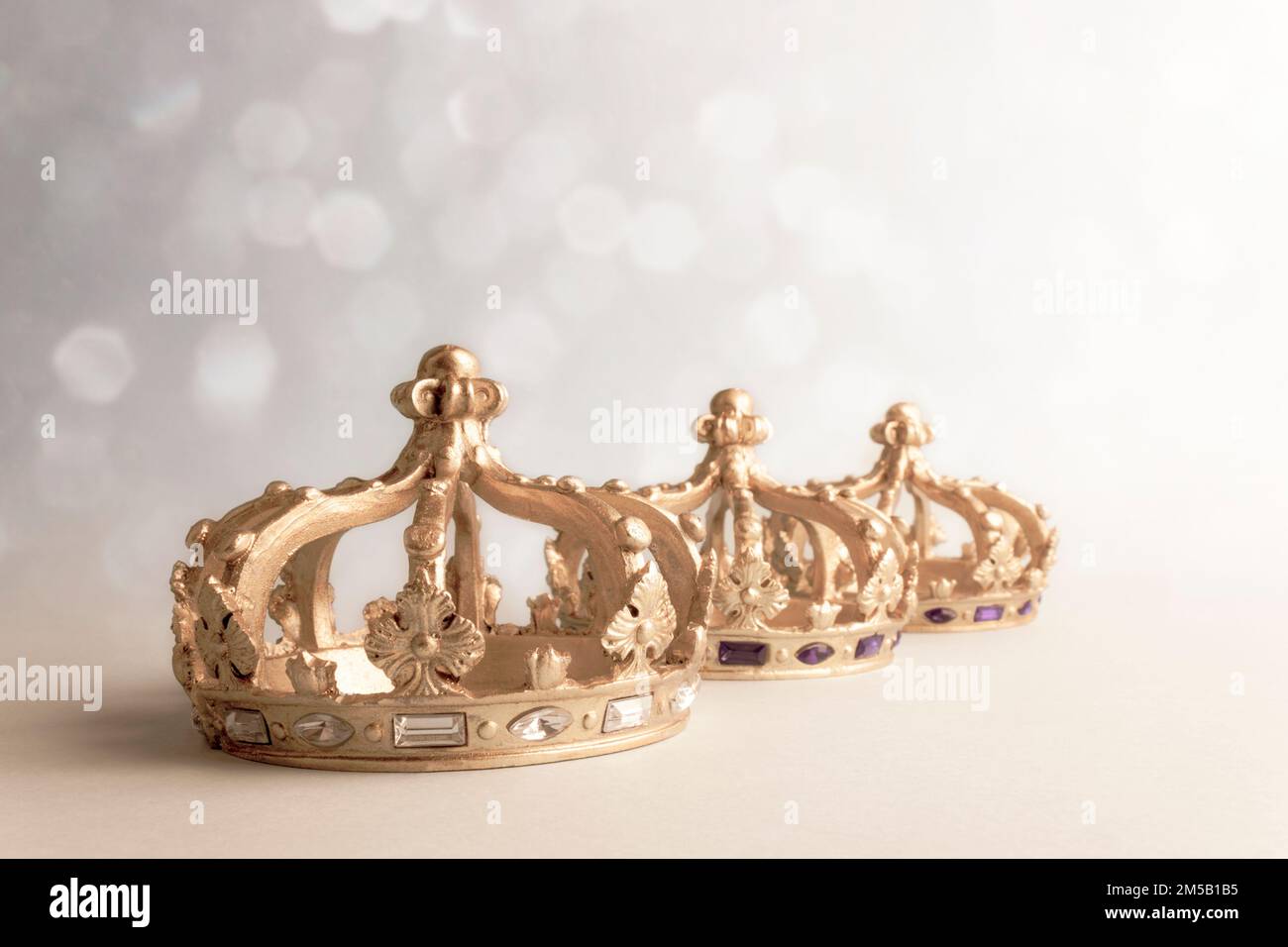 Happy Three King's Day. Three golden color crowns on light background ...
