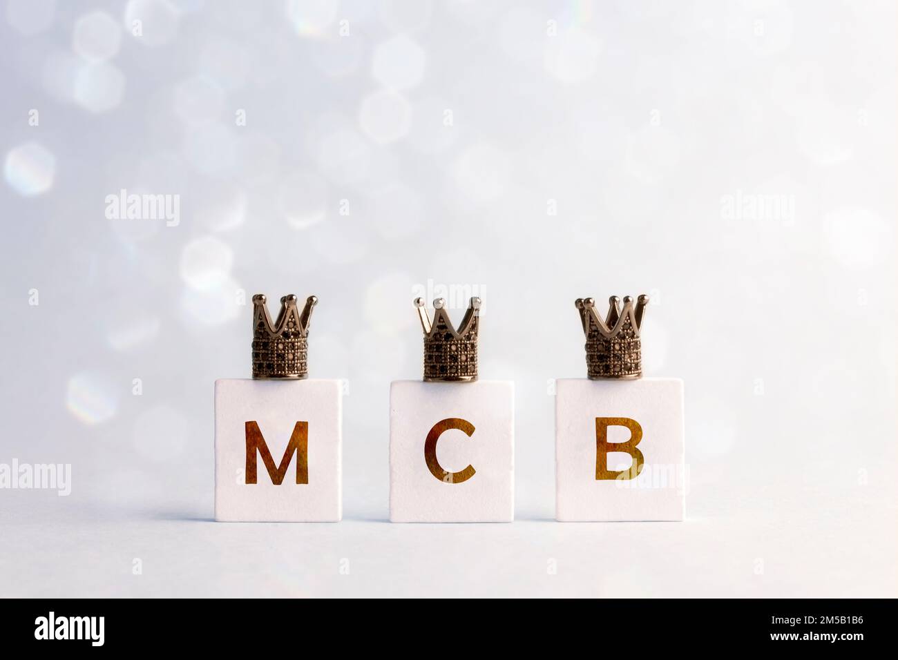 Happy Three King's Day. Three letters M, C, B with crowns on light ...