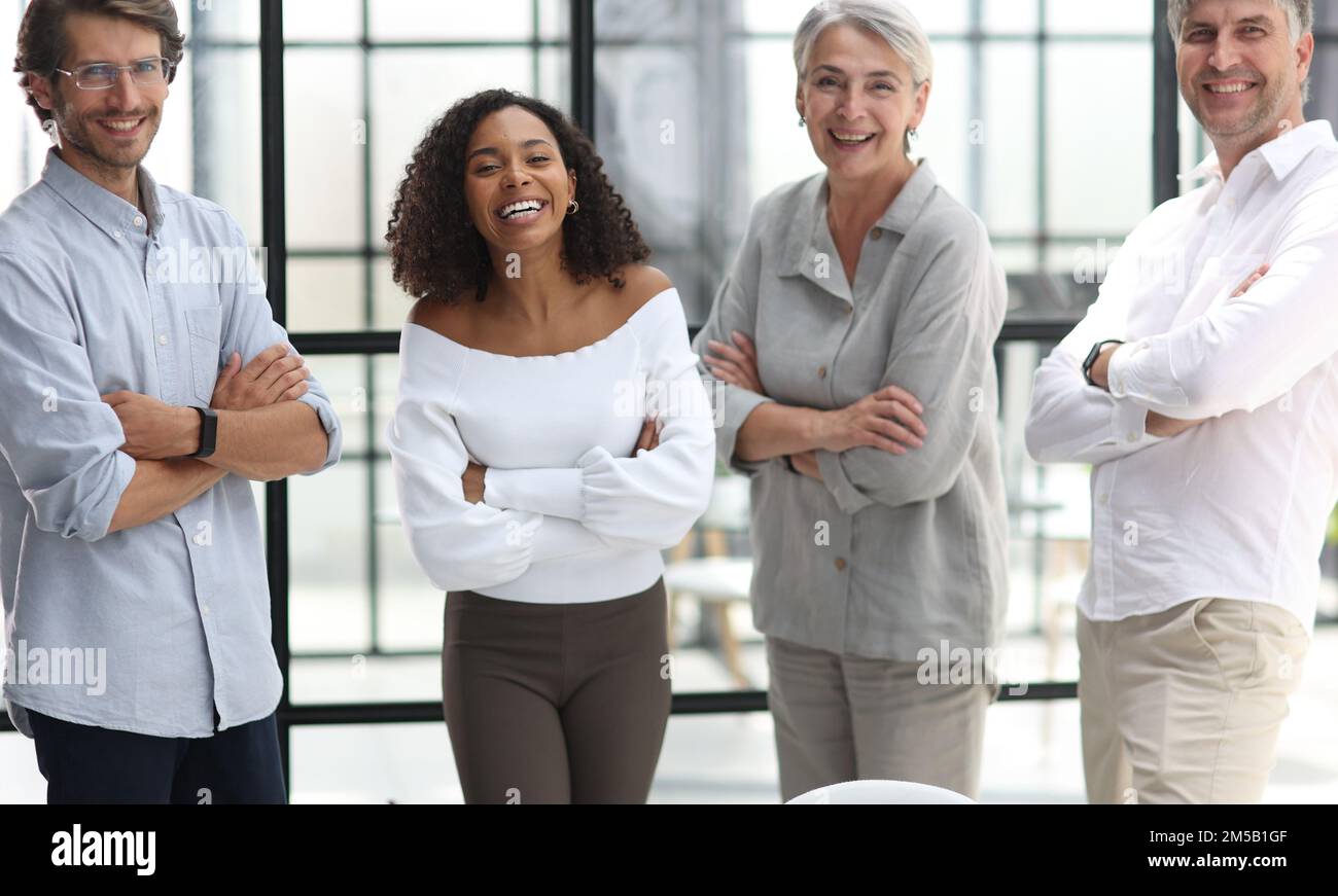 A group of young modern people in smart casual clothes, studying while ...