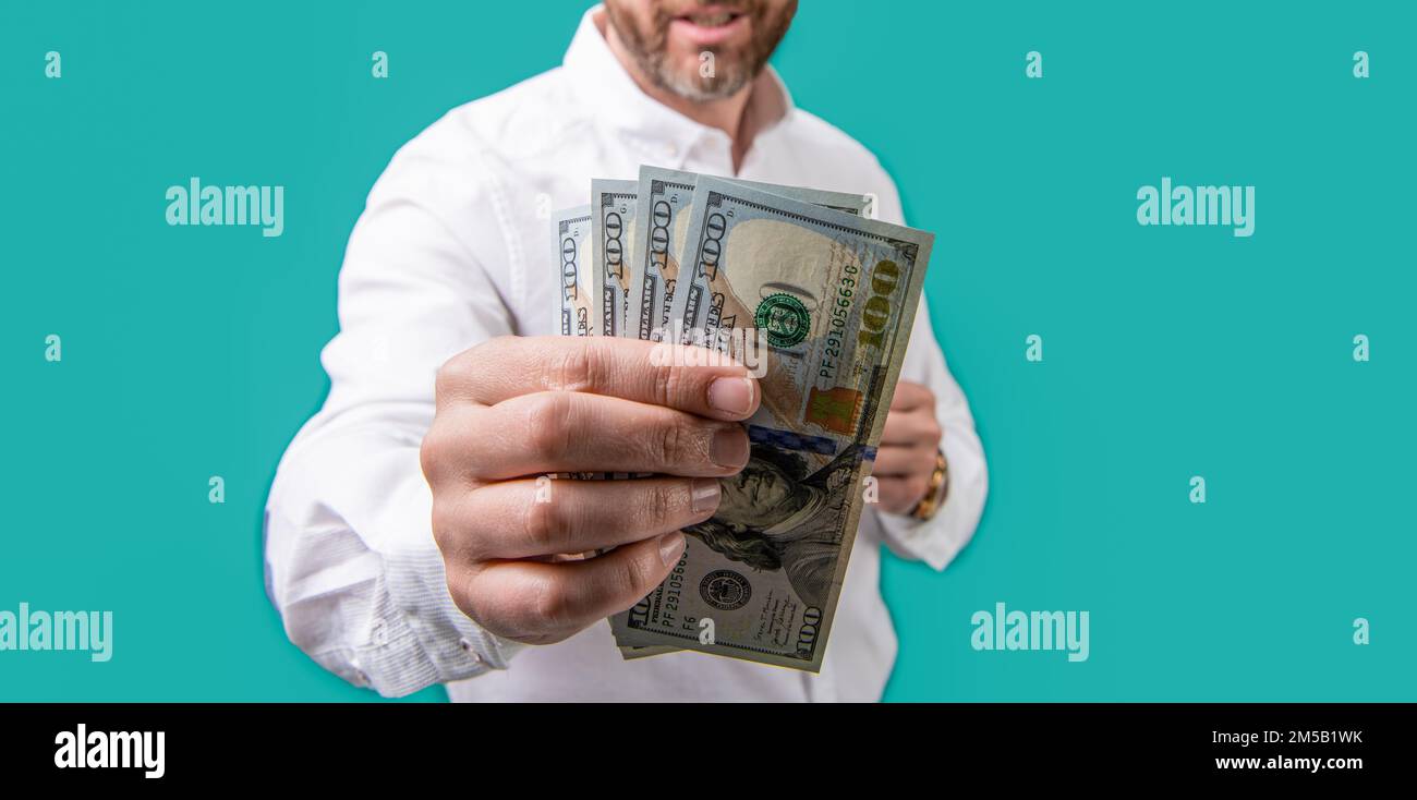 man paying money dollars, studio background. selective focus of paying ...