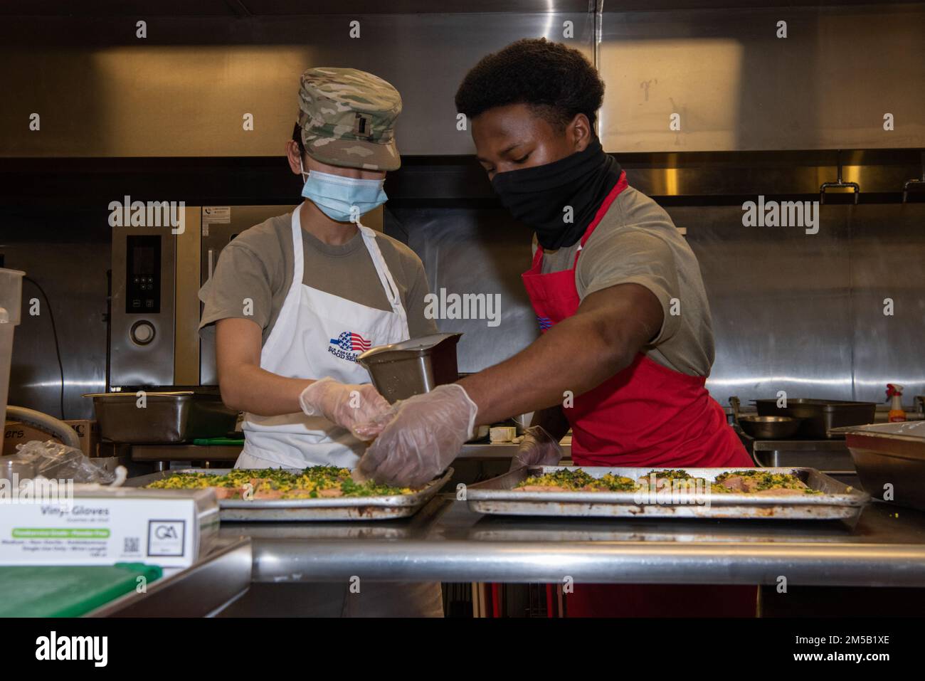 1st Lt. Sheary Mandapat (left), a food service officer assigned to the ...