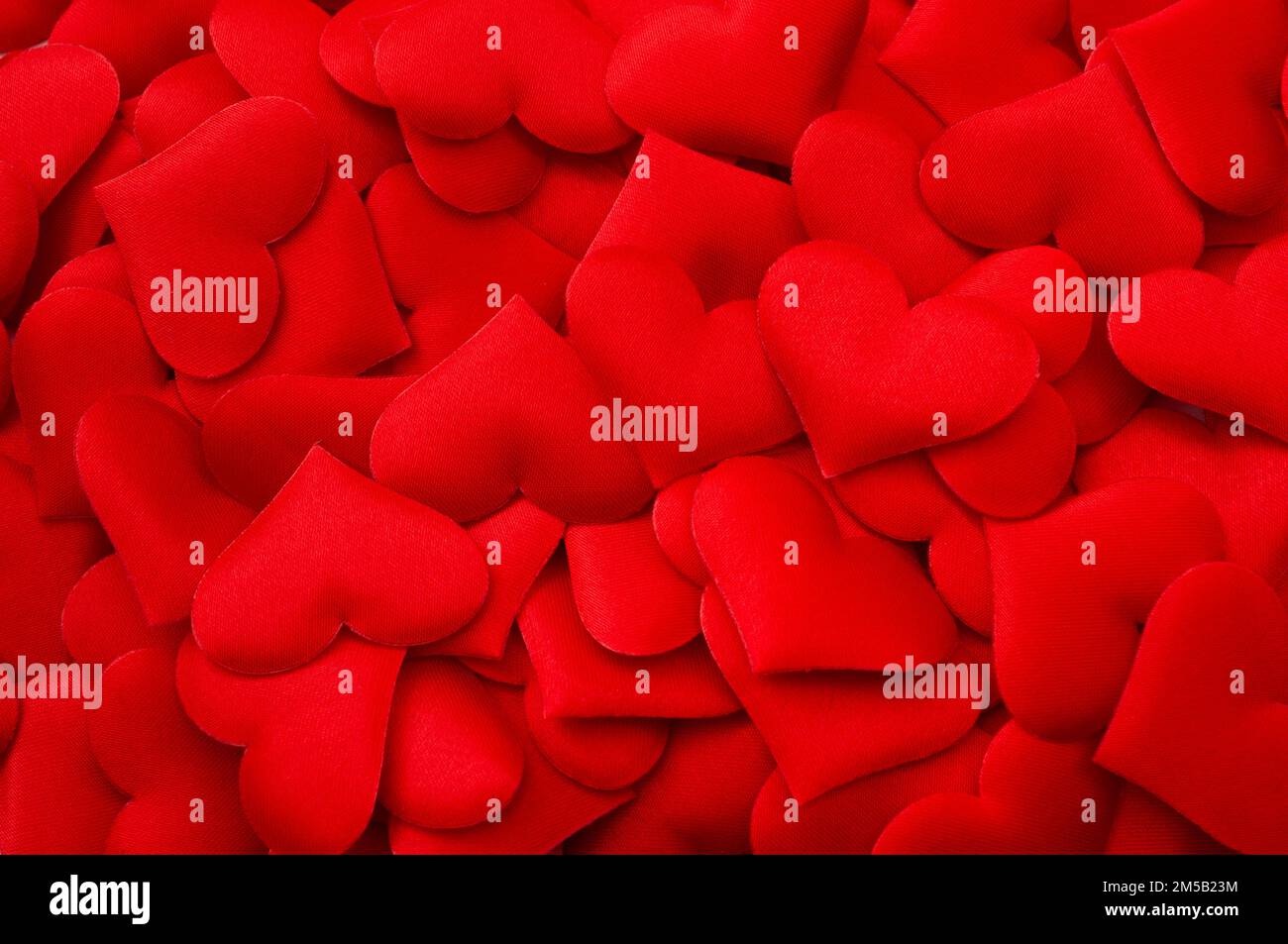 Full frame background of multiple luxurious red satin hearts concept ...