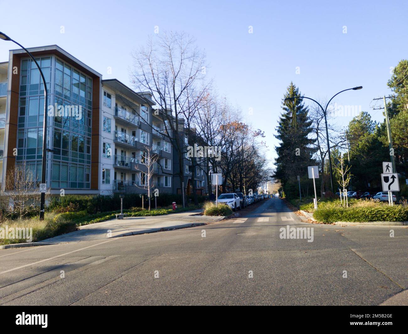 A beautiful shot of a road with building and a park surrounding it ...