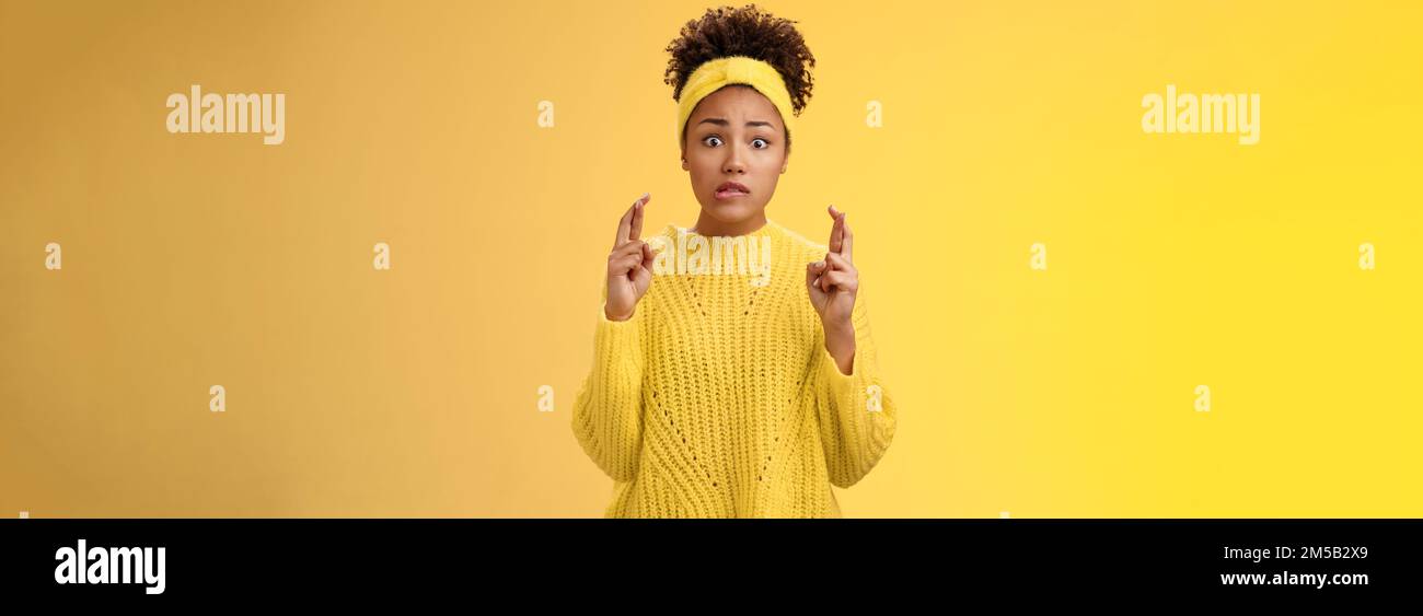 Nervous unsure hesitant young girl hope get fortune luck cross fingers ...