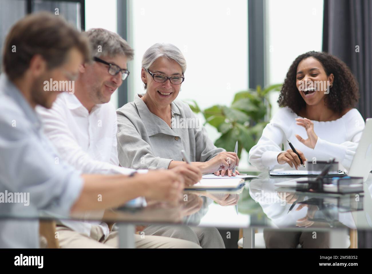 Conversation between managers and employees in the office at the table ...