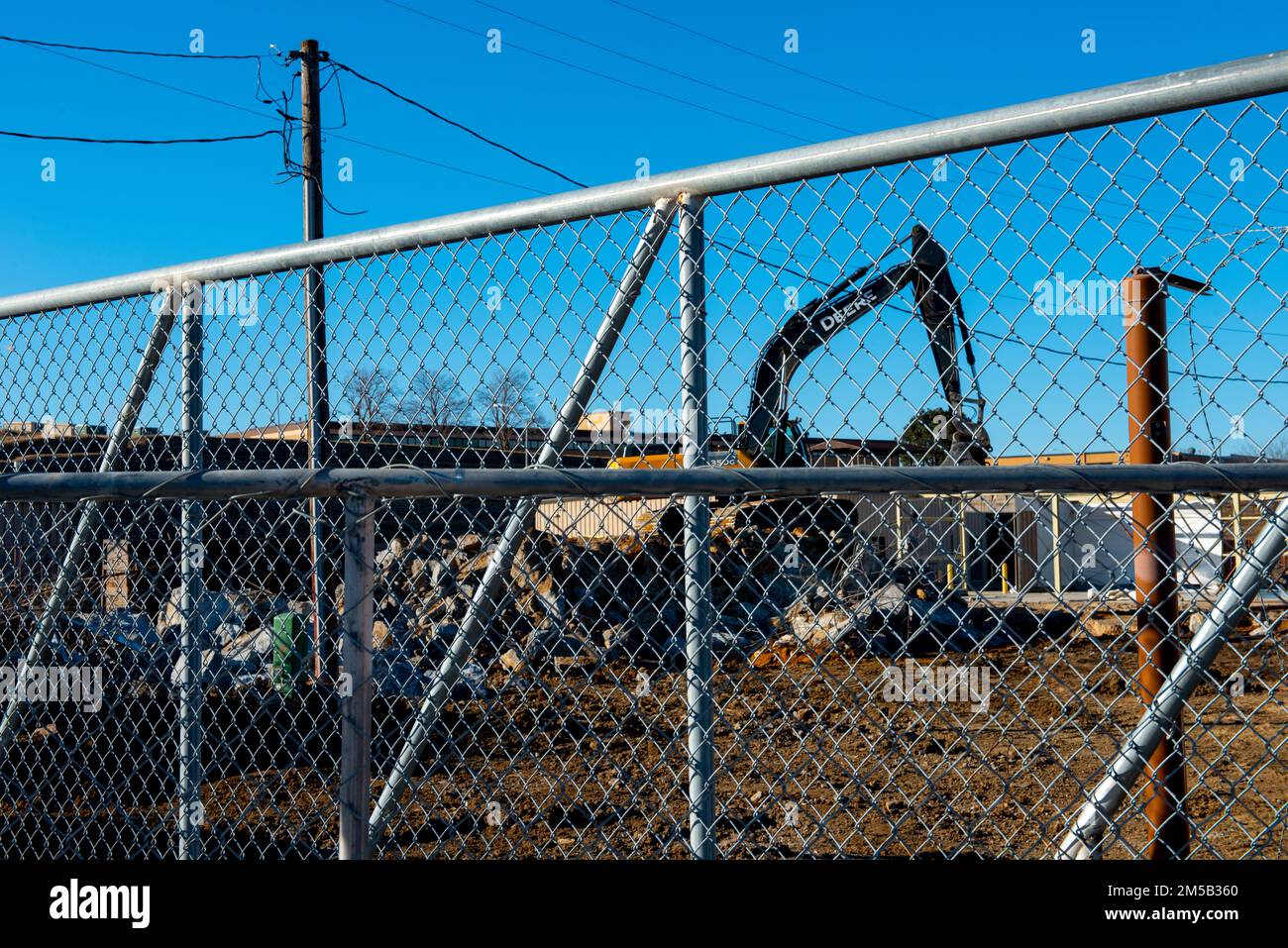 Heavy machinery removes rubble after a building is demolished on Offutt ...