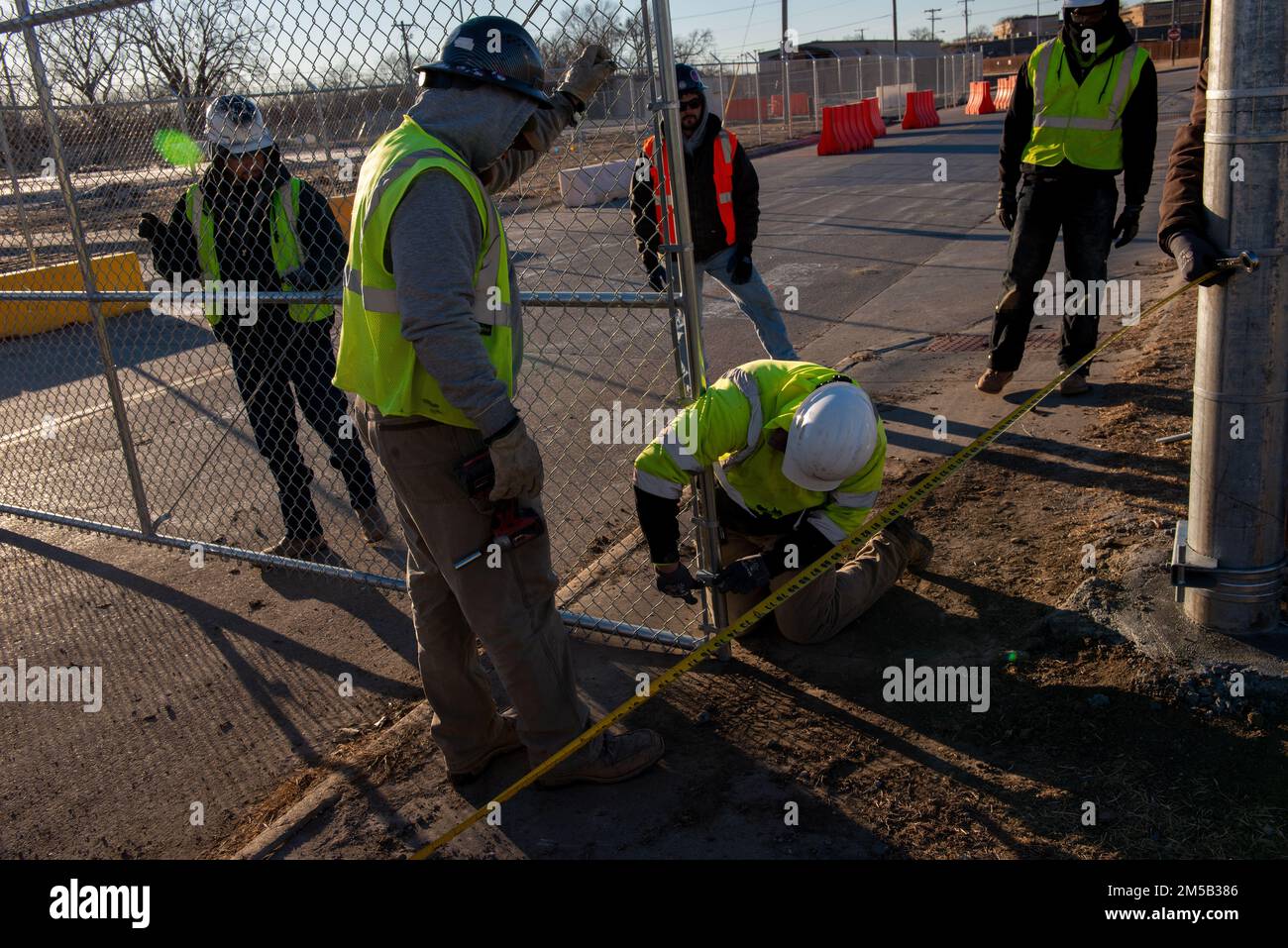 Contractors install the fence around the new construction site at ...