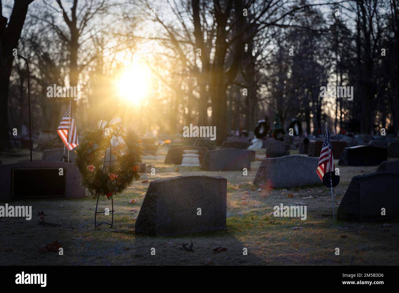 The sun rises on American flags and Christmas wreaths at a Wisconsin ...